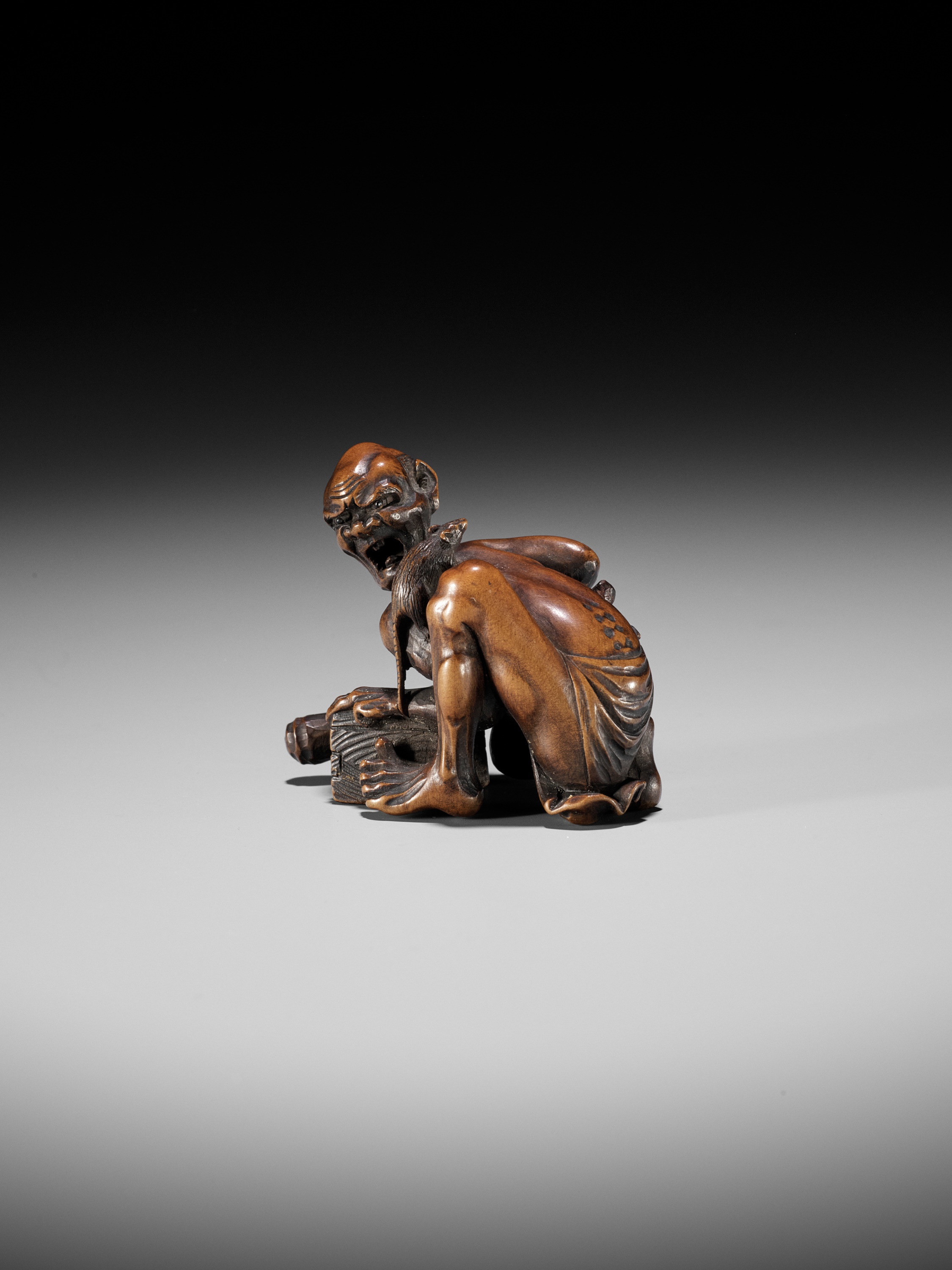 Lot 120 - A FINE WOOD OKIMONO NETSUKE OF AN EMACIATED
