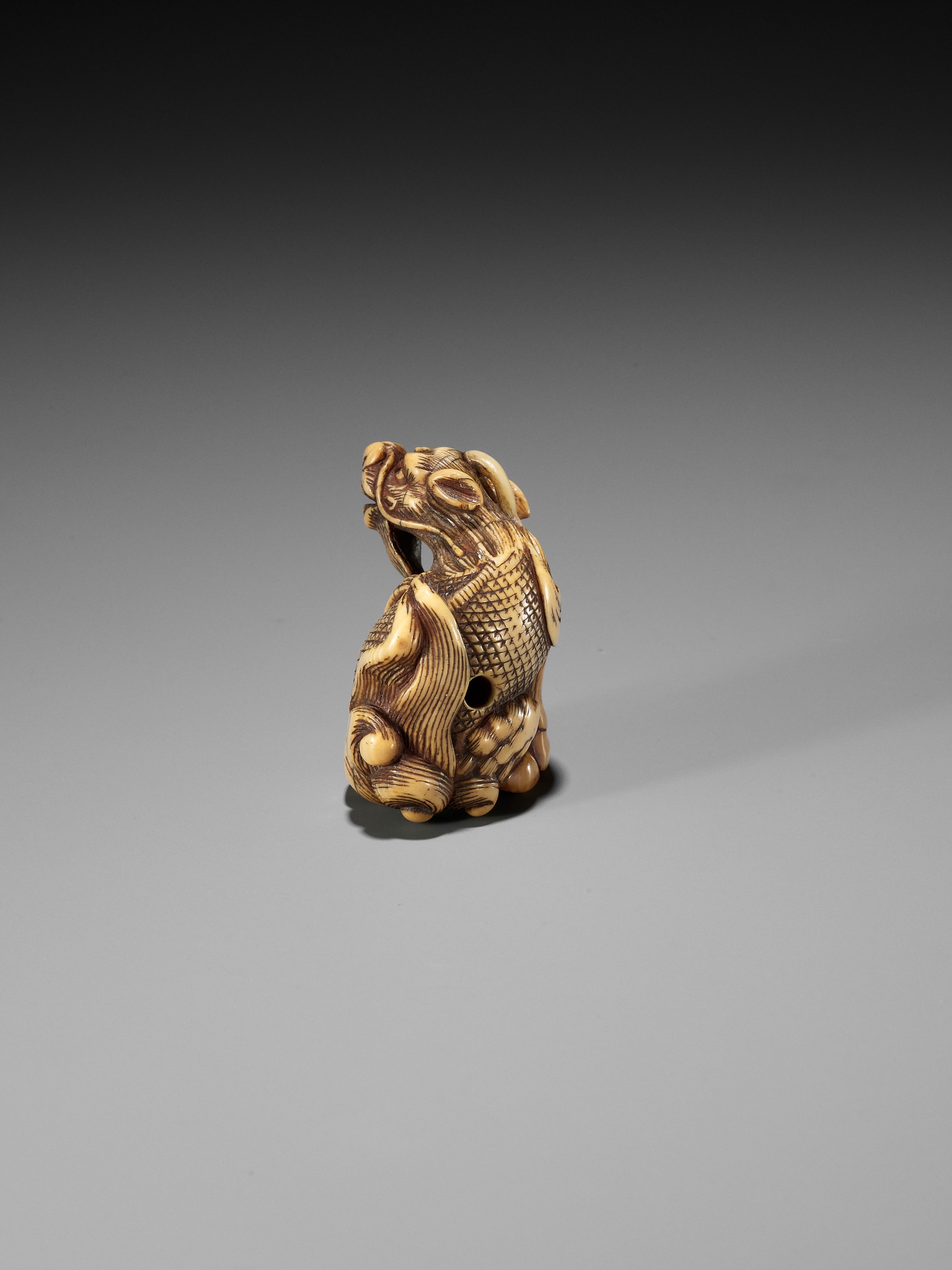 Lot 31 - GYOKUZAN: AN IVORY NETSUKE OF A KIRIN