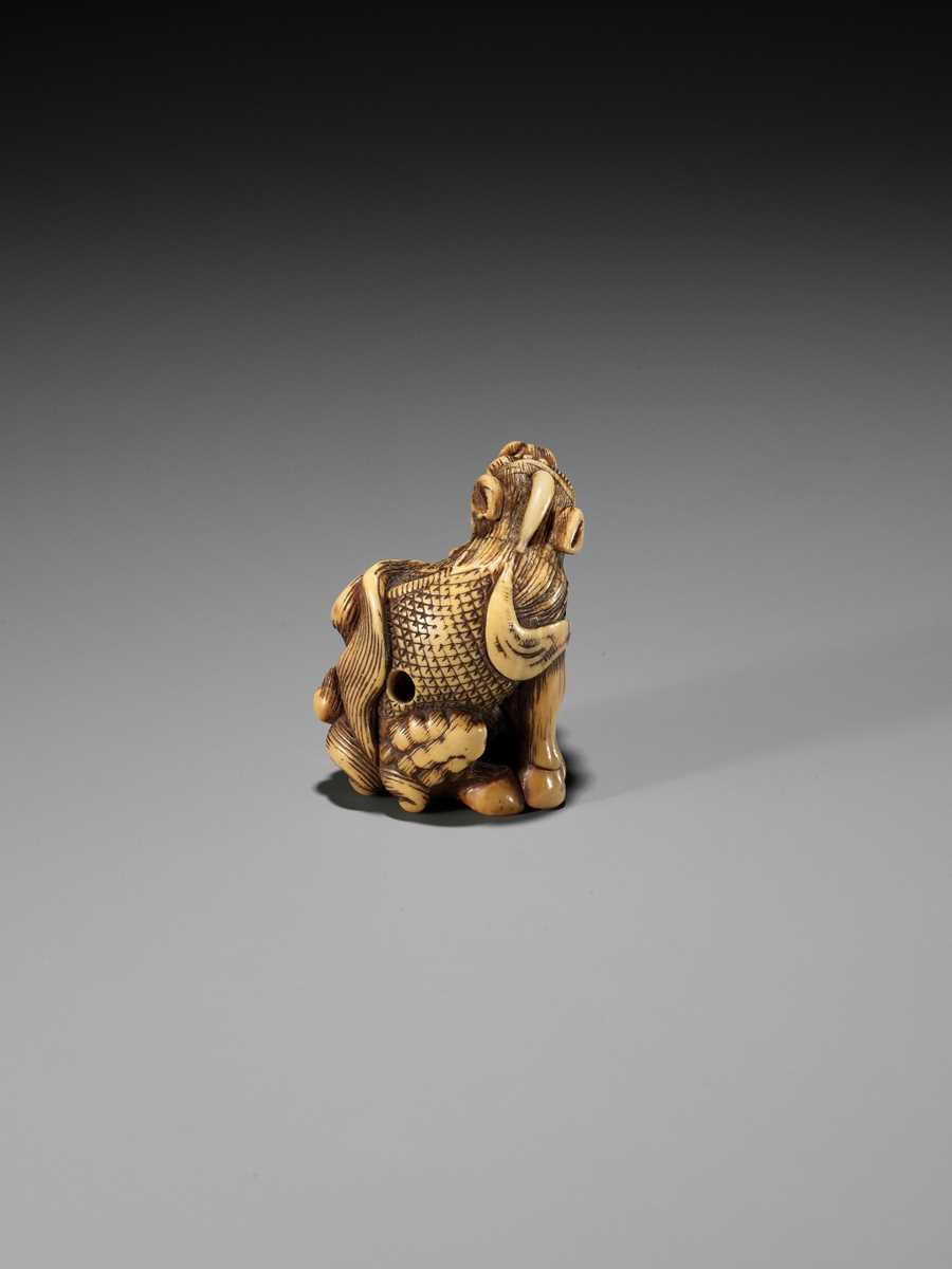 Lot 31 - GYOKUZAN: AN IVORY NETSUKE OF A KIRIN