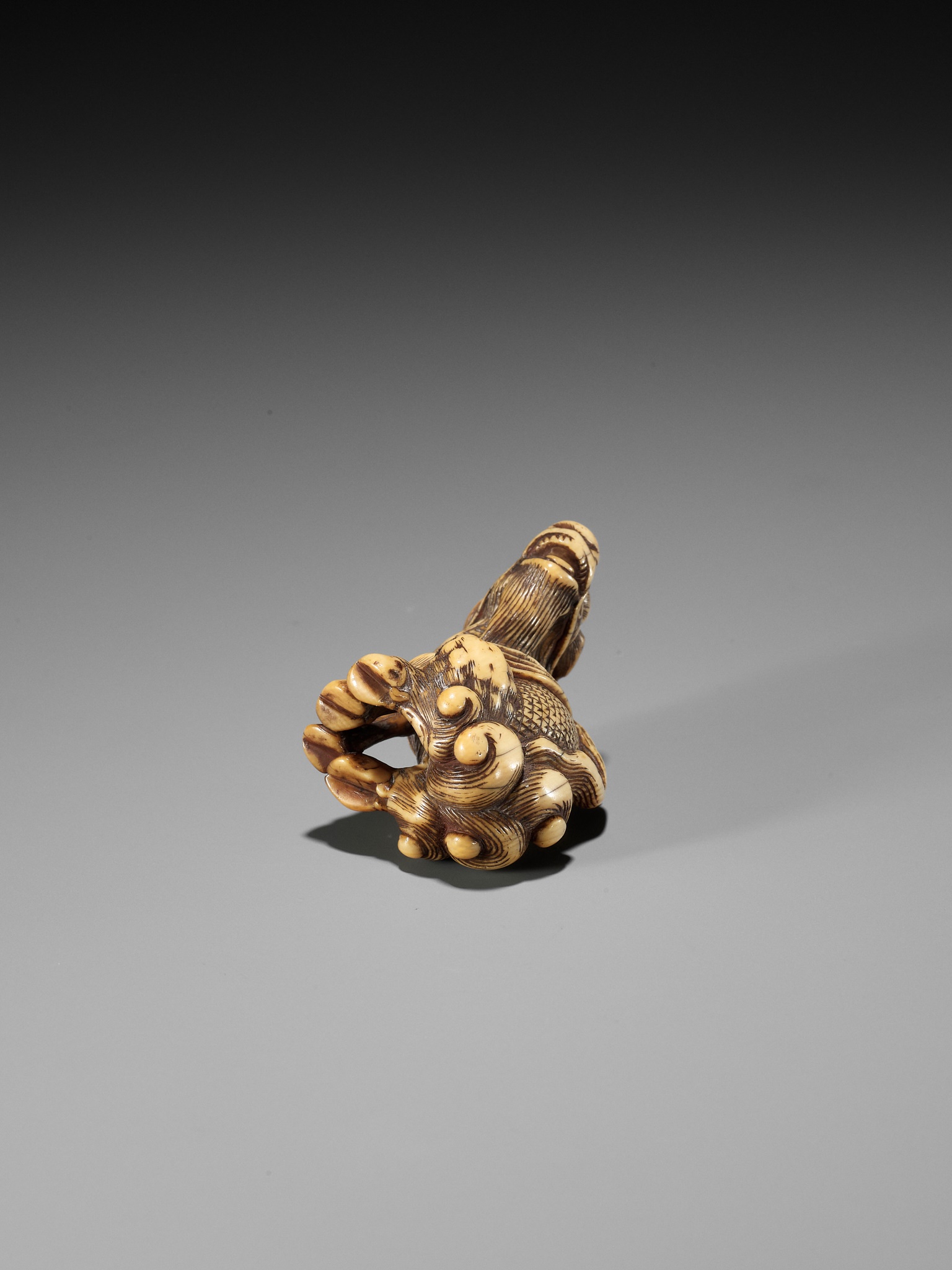 Lot 31 - GYOKUZAN: AN IVORY NETSUKE OF A KIRIN