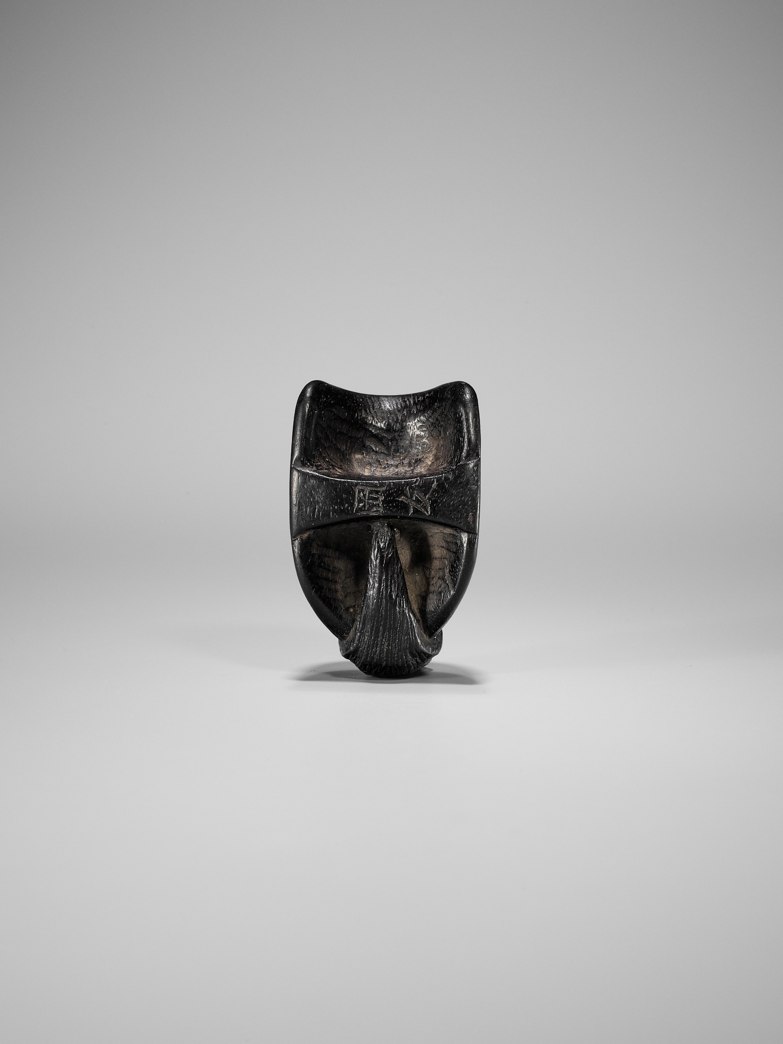 Lot 249 - OKATOMO: A VERY RARE EBONY WOOD MASK NETSUKE