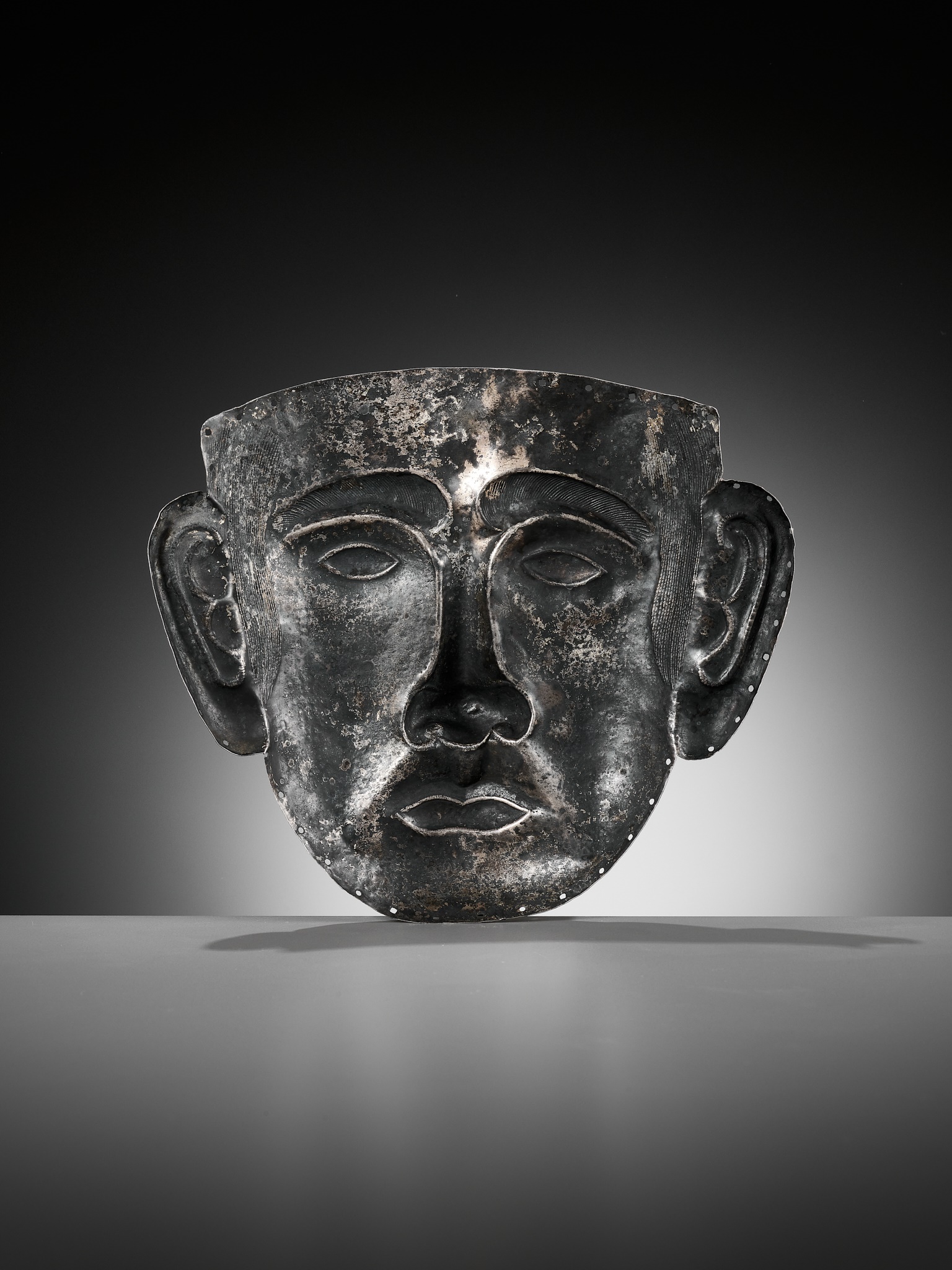 Lot 107 - A SILVER FUNERARY MASK OF A NOBLEMAN, LIAO