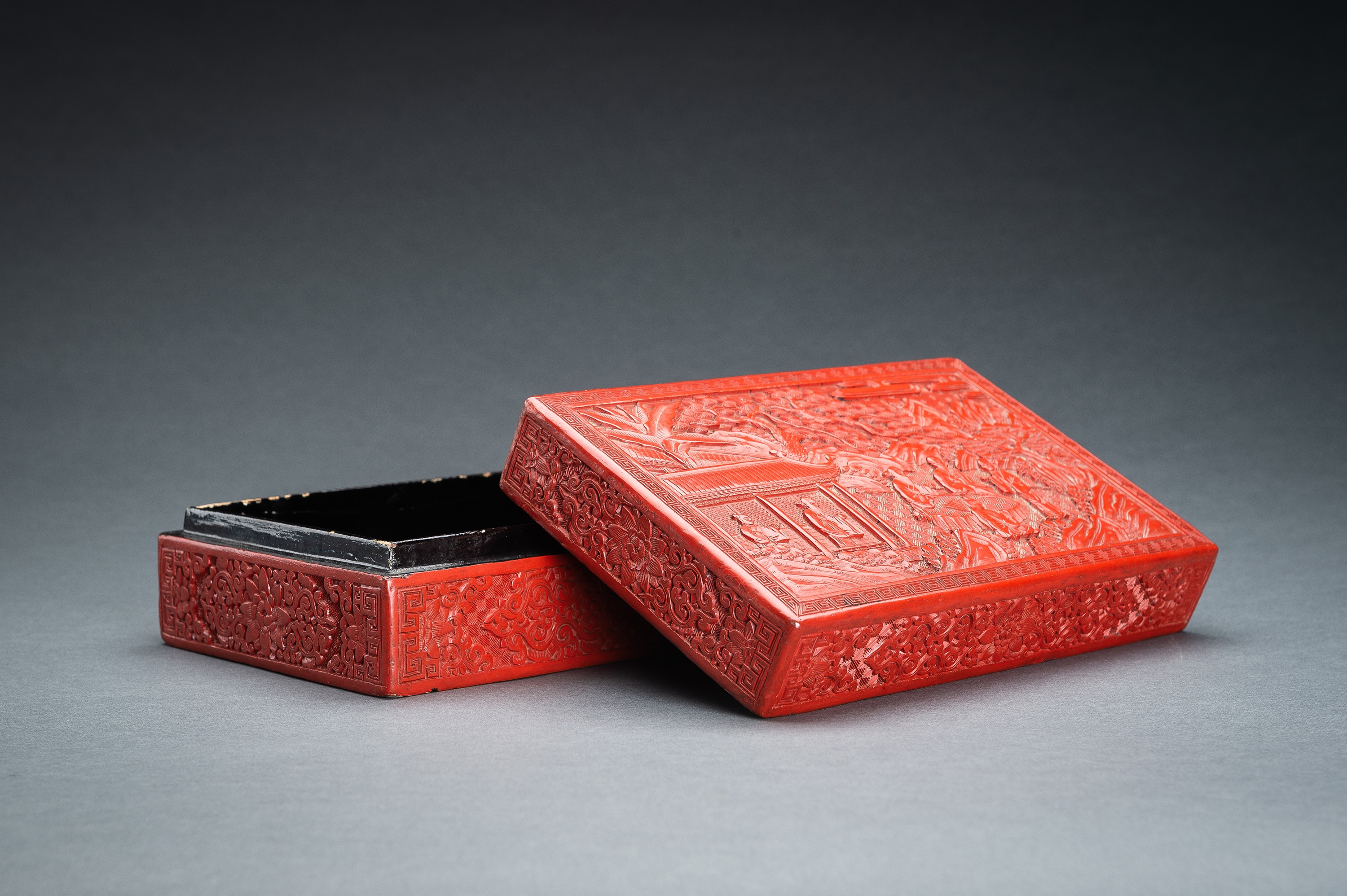 Lot 23 - A CINNABAR LACQUER ‘SCHOLAR’ BOX AND COVER,