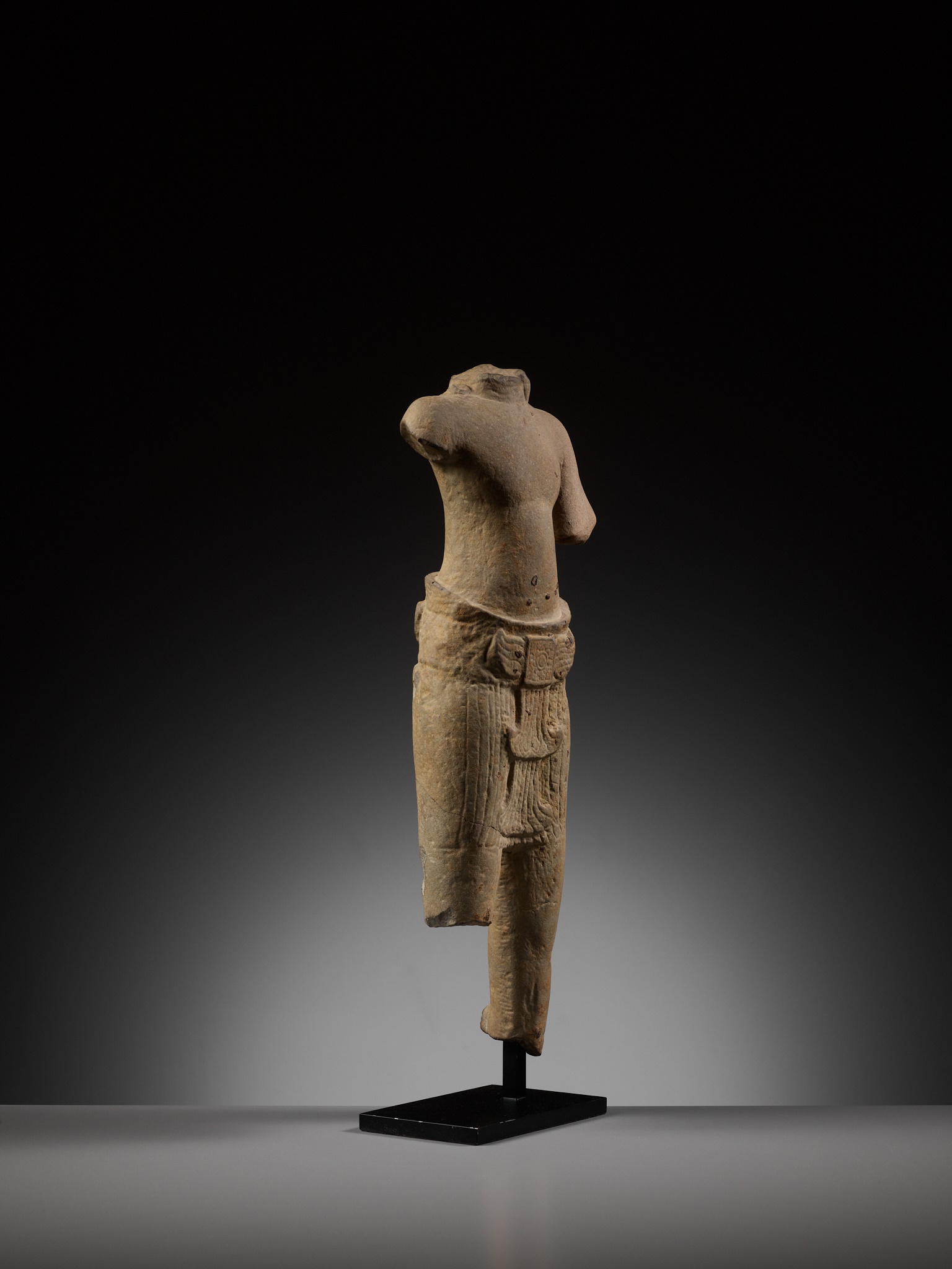 Lot 275 - A SANDSTONE TORSO OF A MALE DEITY, KHMER,