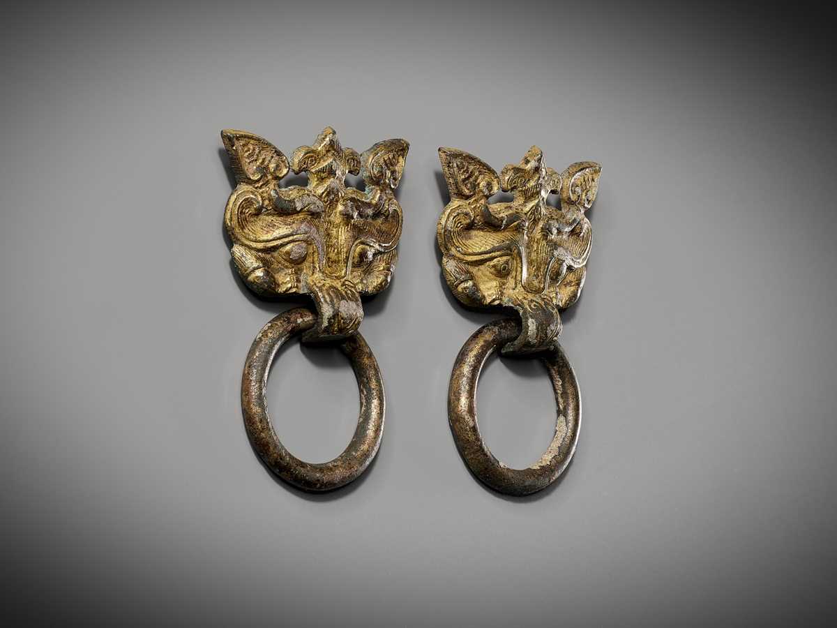 Lot 599 - A PAIR OF GILT-BRONZE TAOTIE MASKS WITH RING