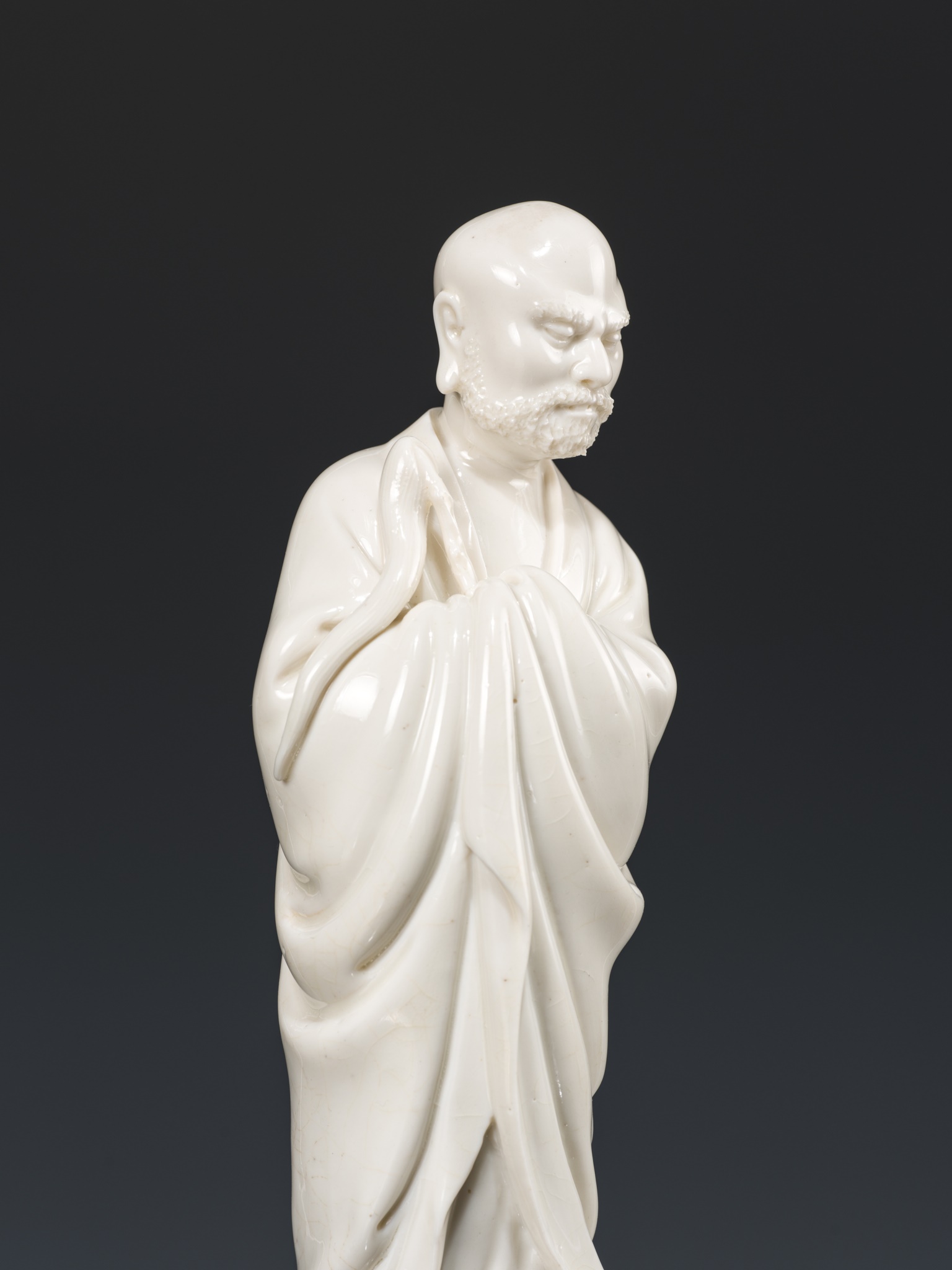 Lot 81 - A DEHUA FIGURE OF DAMO (BODHIDHARMA), CHINA,