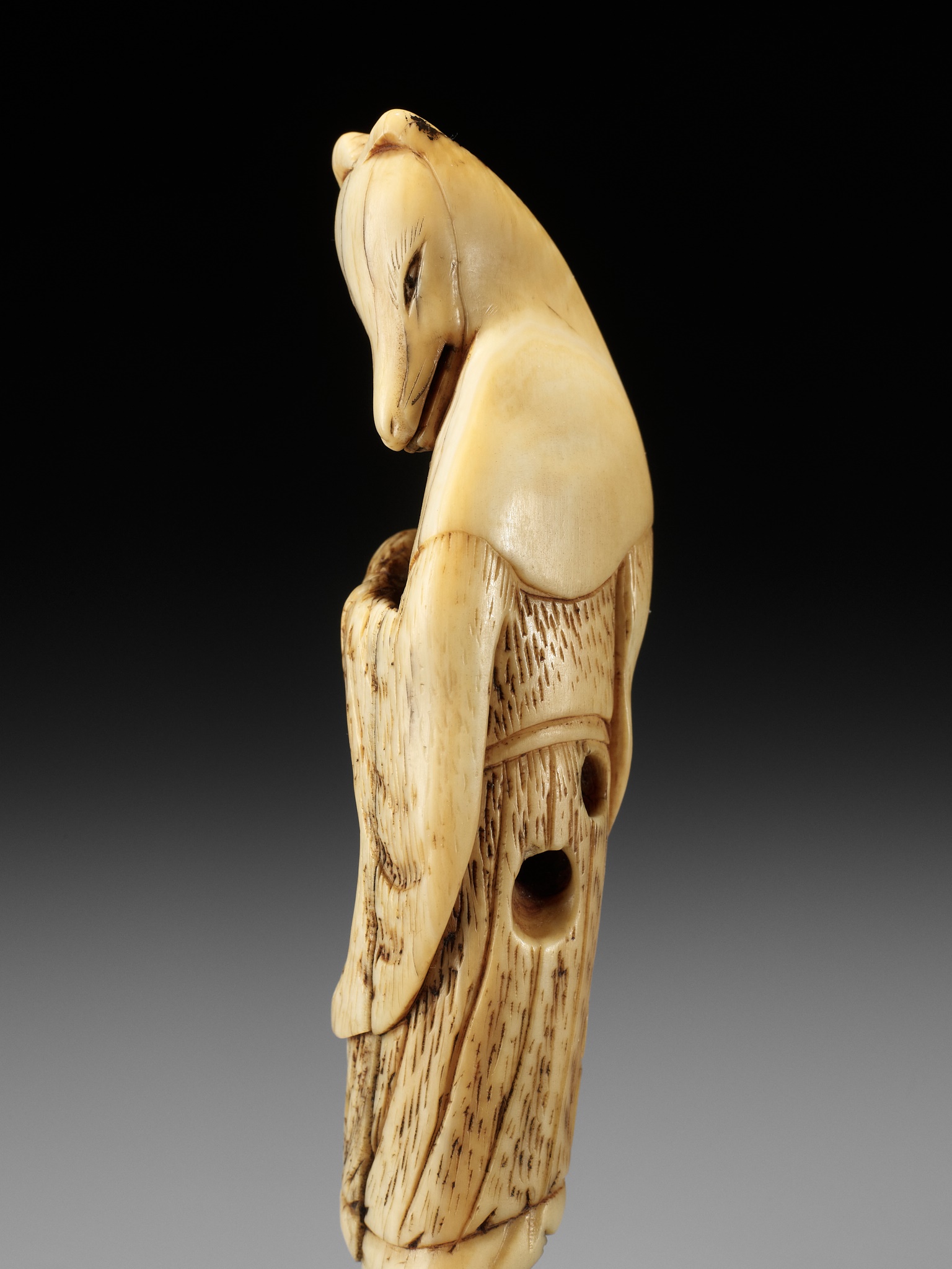 Lot 112 - A GOOD IVORY NETSUKE OF A FOX PRIEST