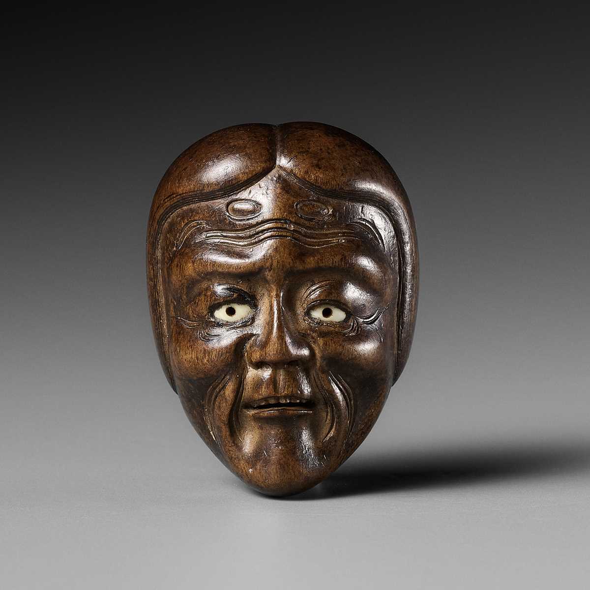 Lot 500 - SHUGETSU: A FINE WOOD MASK NETSUKE OF