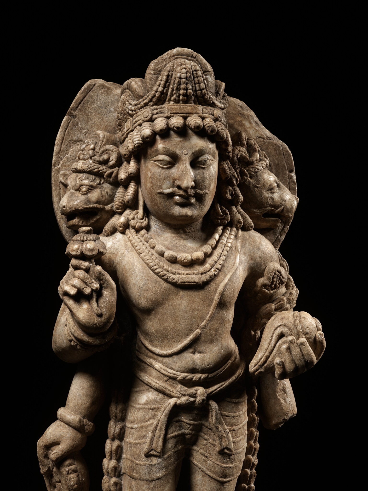 Lot 234 - A LIMESTONE FIGURE OF THE THREE-HEADED