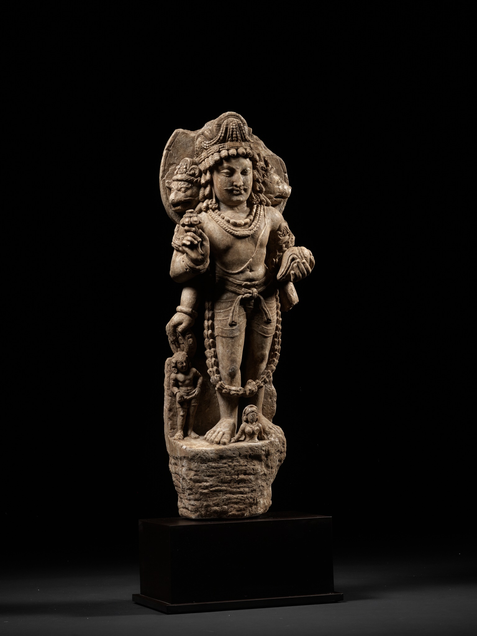 Lot 234 - A LIMESTONE FIGURE OF THE THREE-HEADED