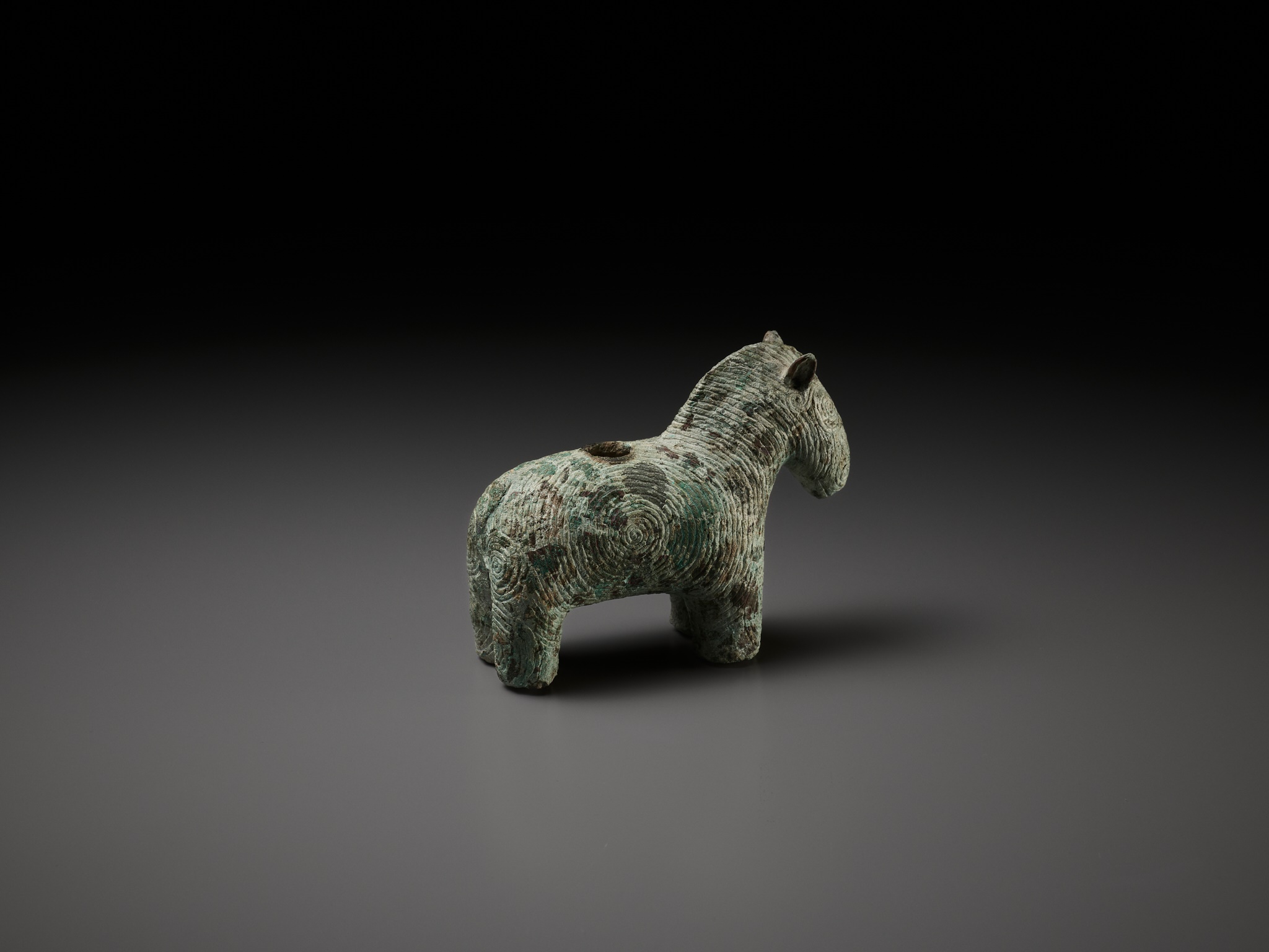 Lot 299 - A RARE BRONZE HORSE-FORM VESSEL, DONG SON