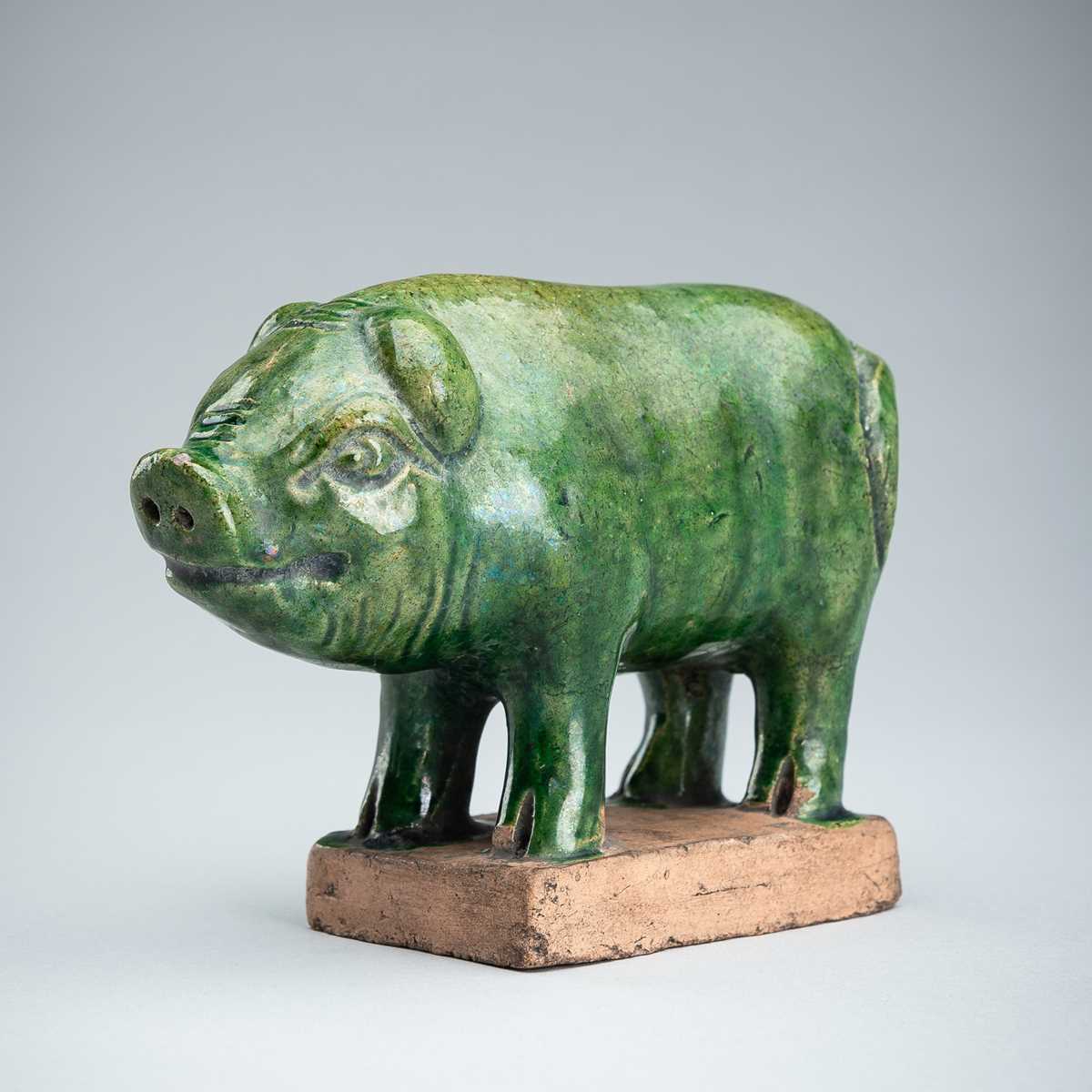 Lot 1237 - AN EMERALD-GREEN GLAZED POTTERY PIG, MING