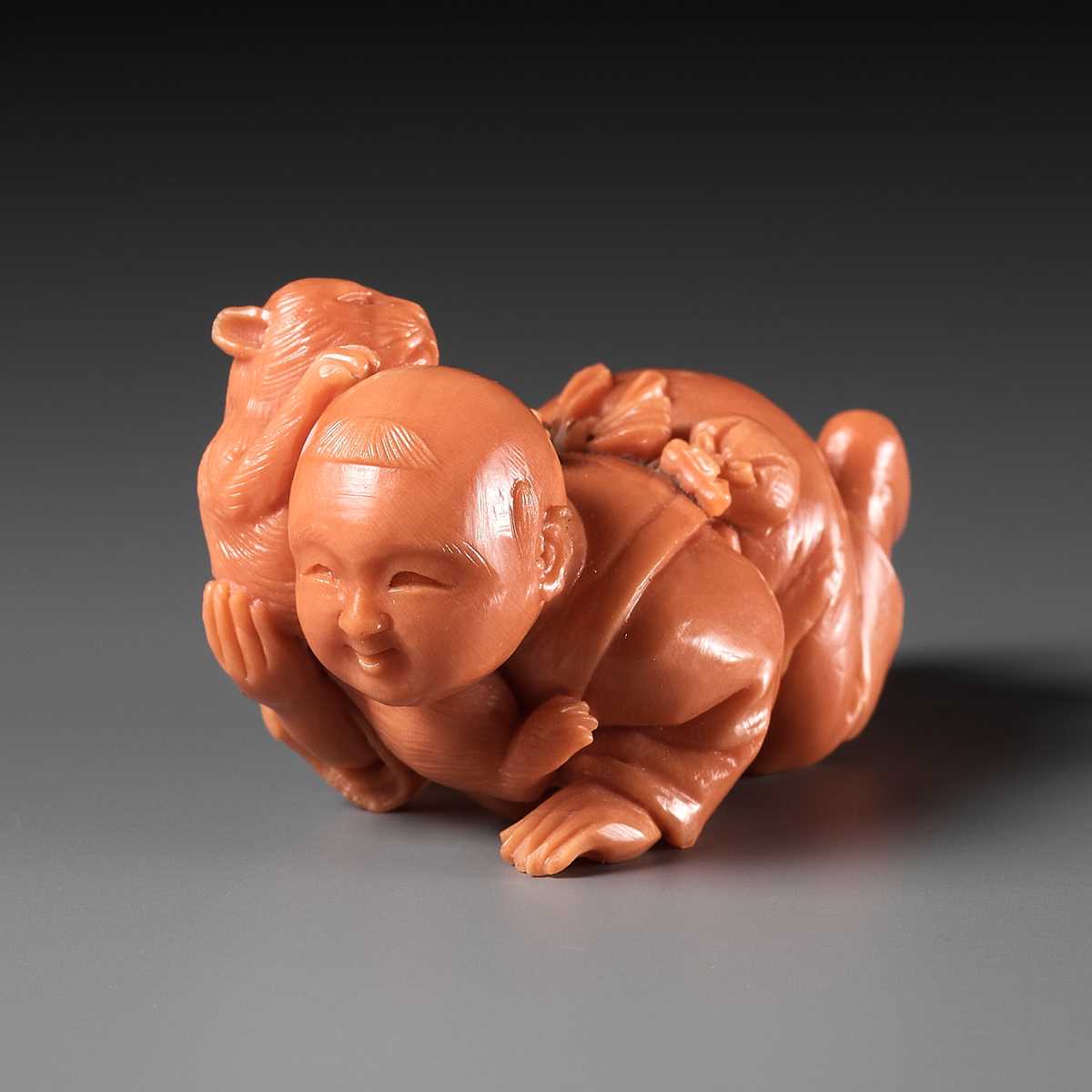 Lot 305 - RYUHO: A VERY RARE SOLID CORAL NETSUKE OF A