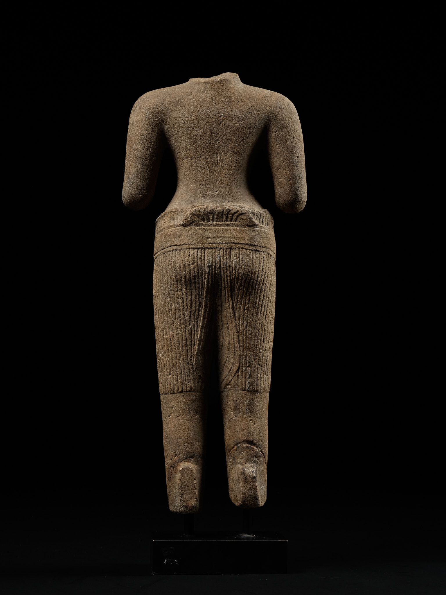 Lot 187 - A KHMER GRAY SANDSTONE TORSO OF A MALE DEITY,