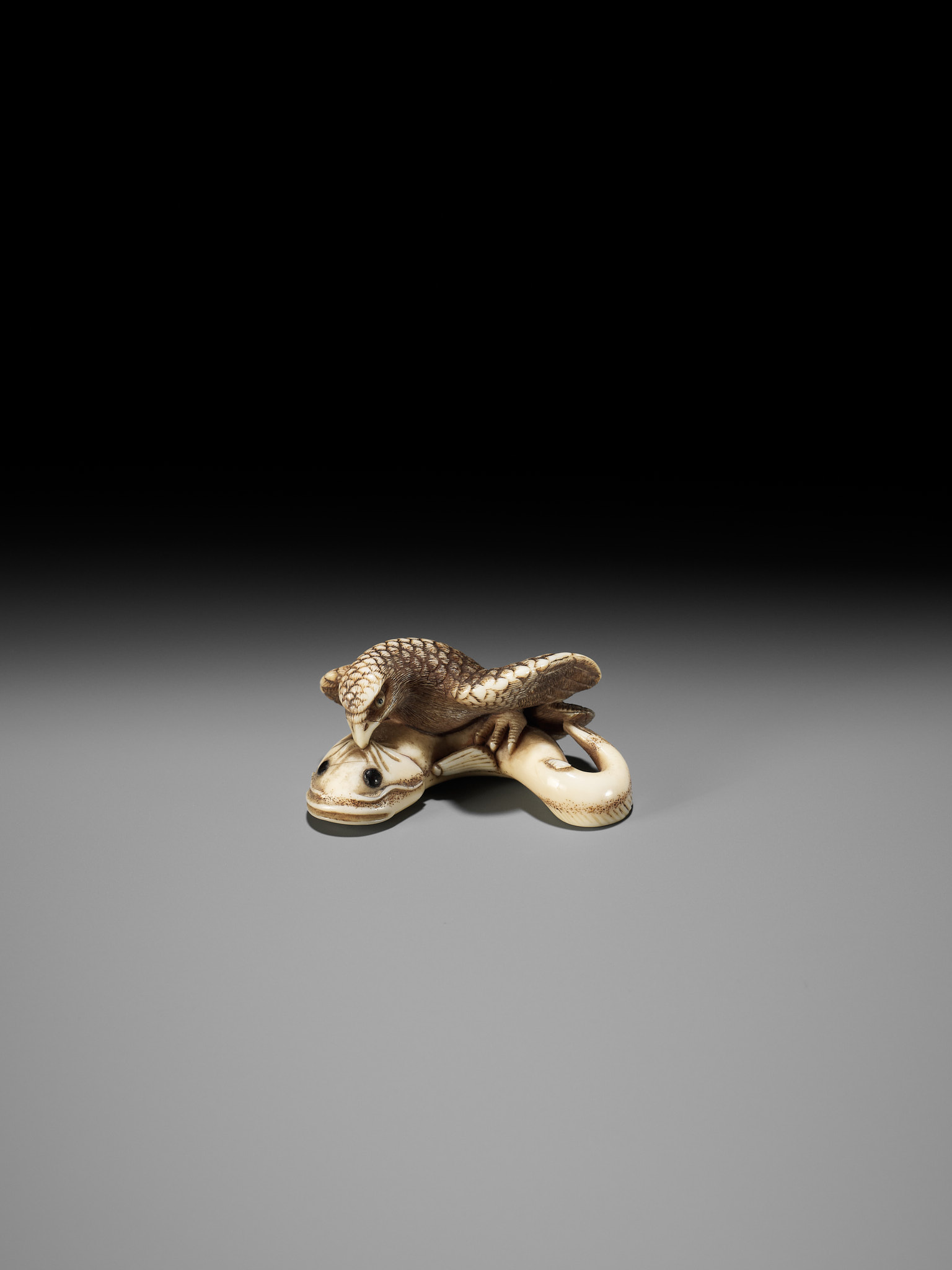 Lot 74 - HIDEMASA: A FINE IVORY NETSUKE OF AN EAGLE