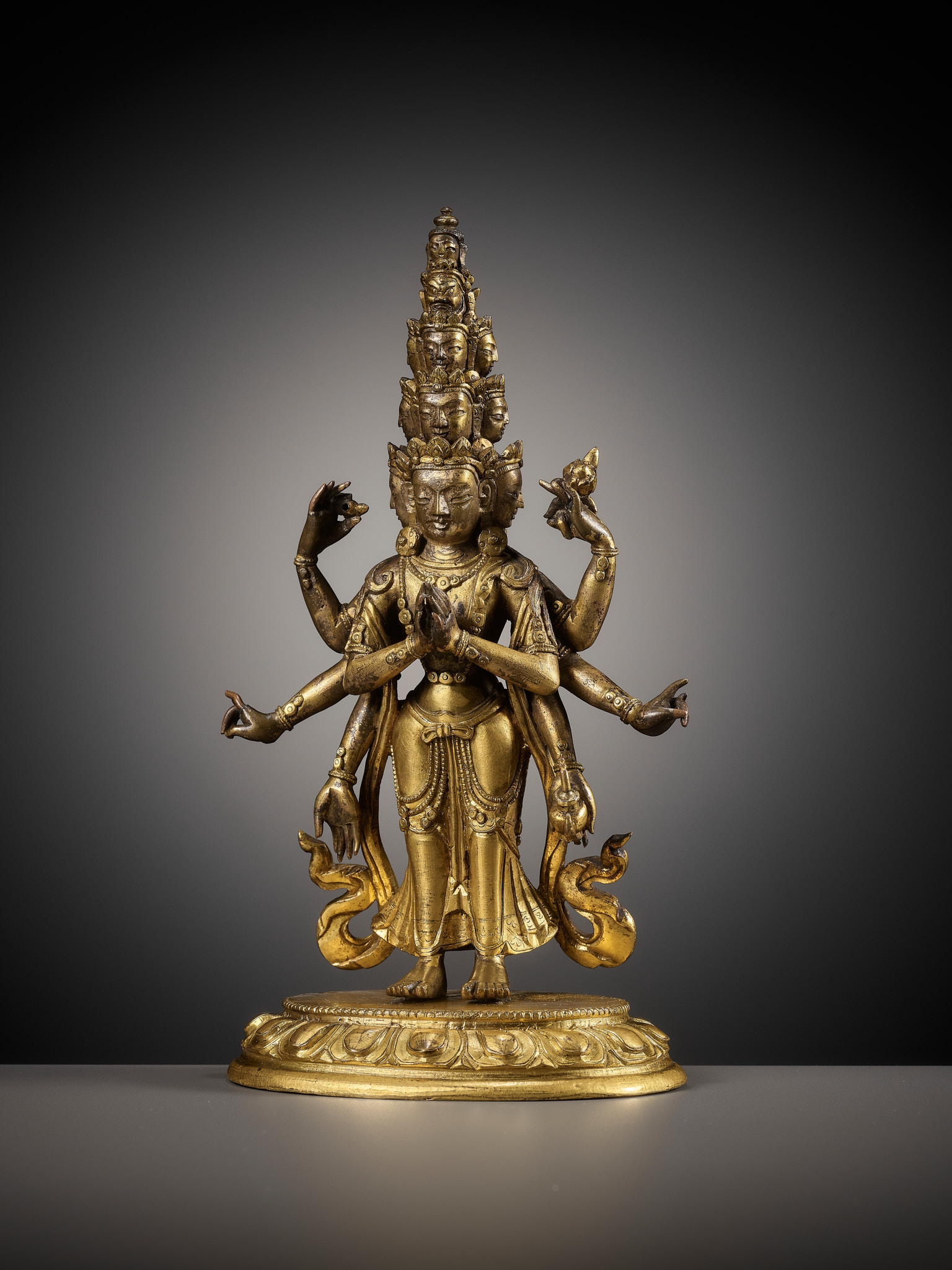 Lot 46 - A GILT-BRONZE FIGURE OF EKADASHAMUKHA