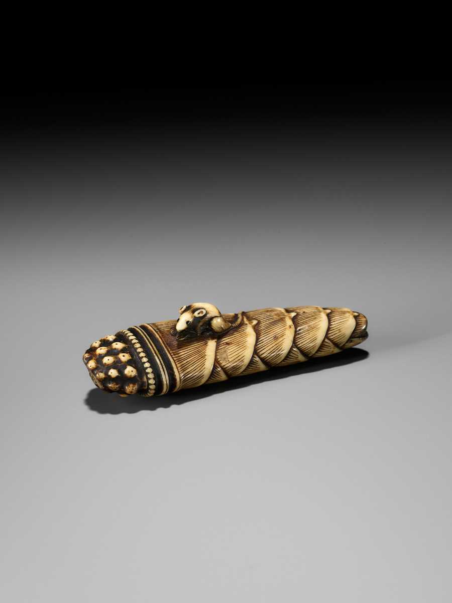 Lot 261 - AN EARLY ANTLER NETSUKE DEPICTING A RAT ON A