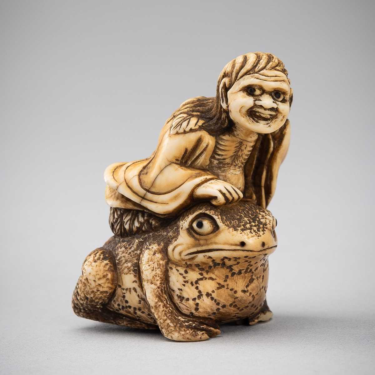 Lot 451 - AN IVORY NETSUKE OF GAMA SENNIN SITTING ON A