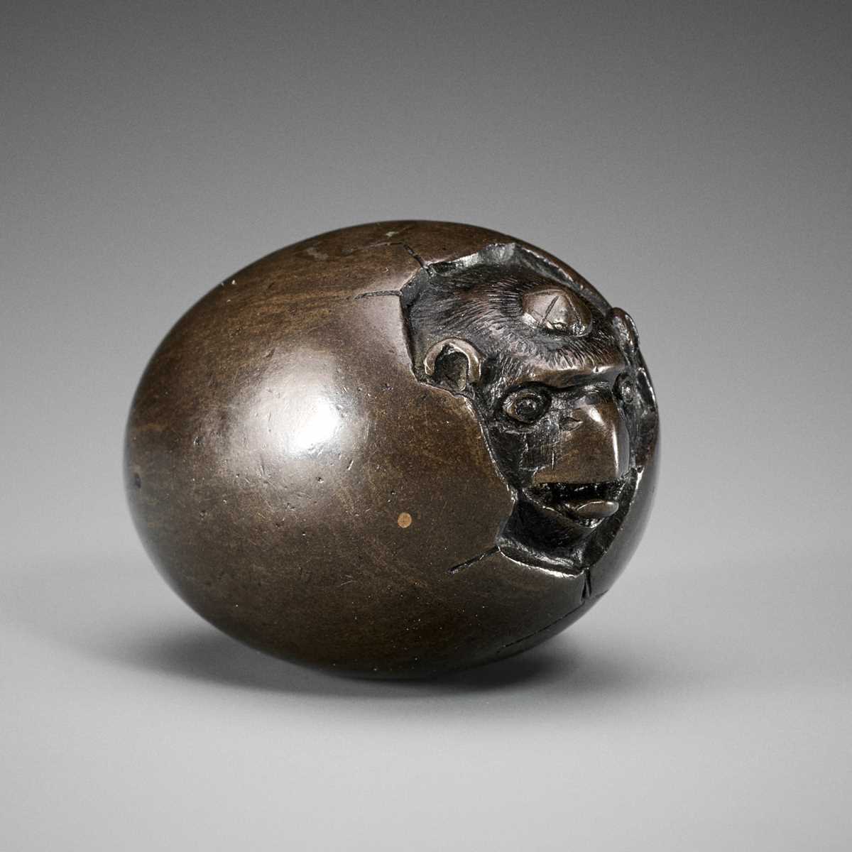 Lot 303 - A RARE BRONZE NETSUKE OF A HATCHING TENGU