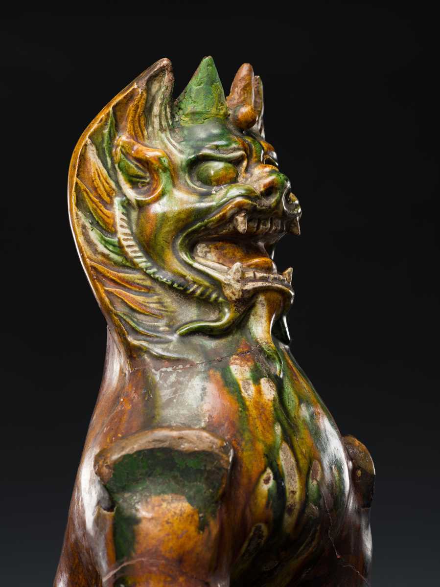 Lot 132 - A SANCAI-GLAZED FIGURE OF A LEONINE EARTH