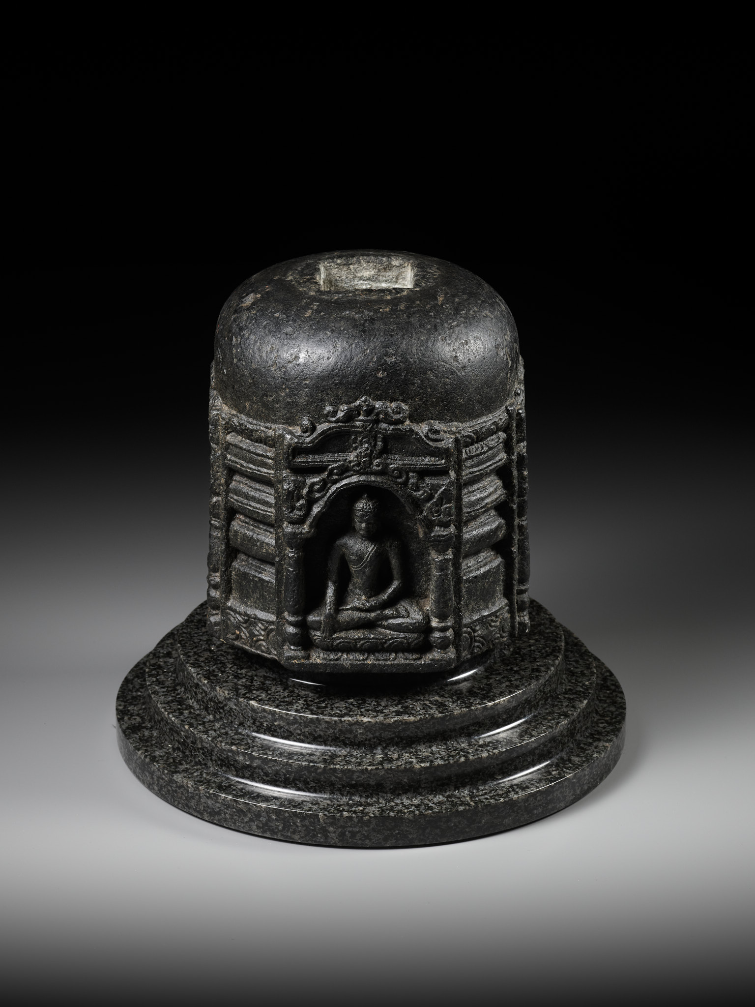 Lot 249 - A BLACK STONE STUPA DRUM WITH FOUR BUDDHAS,