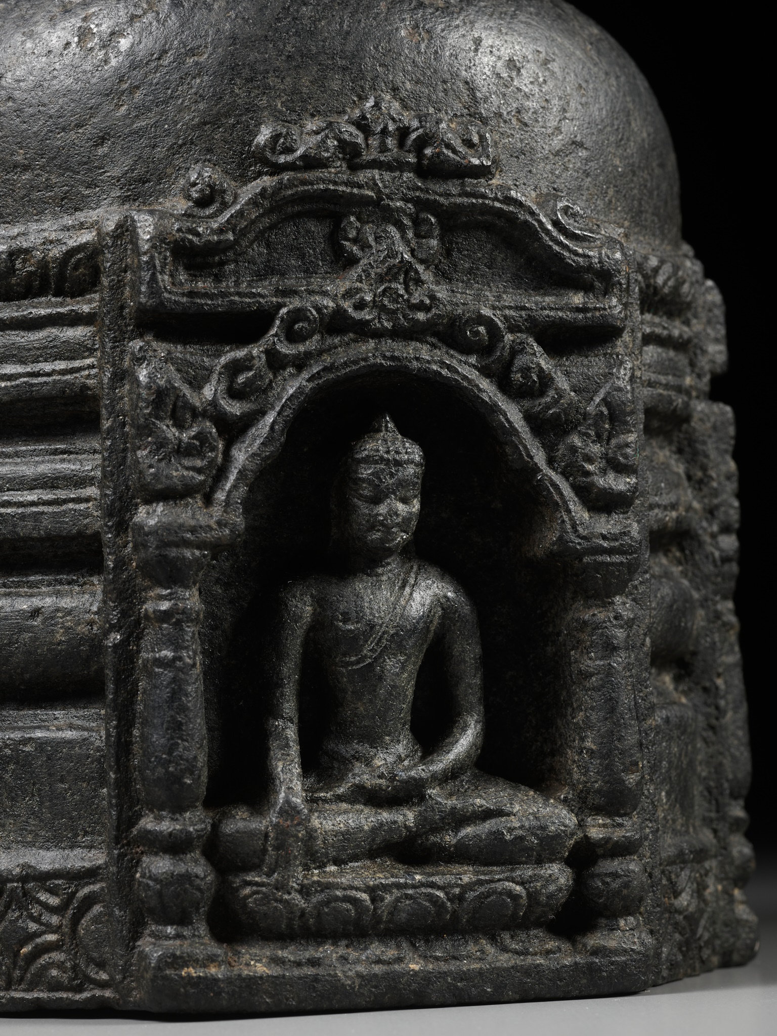 Lot 249 - A BLACK STONE STUPA DRUM WITH FOUR BUDDHAS,