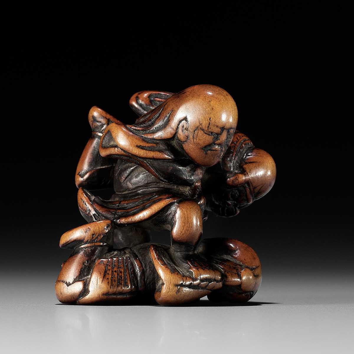 Lot 170 - NAGAMITSU: A RARE WOOD NETSUKE OF GOBAN