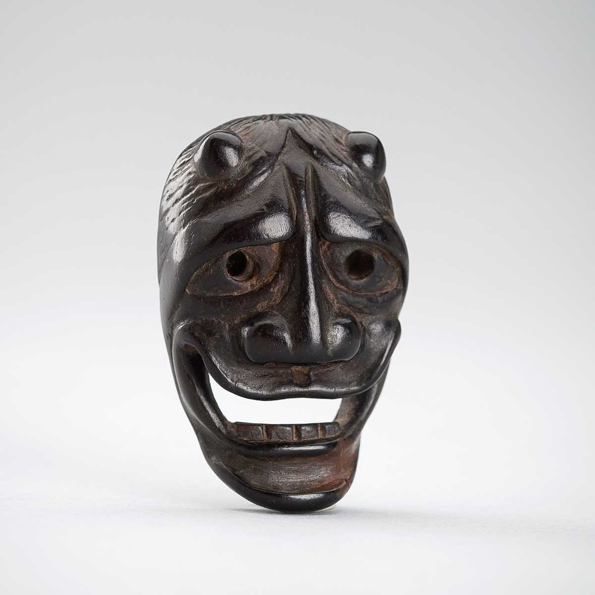 Lot 480 - DEME SUKEMITSU: A WOOD MASK NETSUKE OF