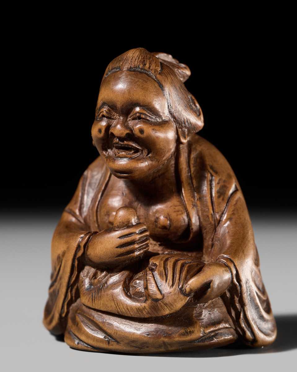 Lot 409 - ONO SHORAKU: A WOOD SHUNGA NETSUKE OF OKAME
