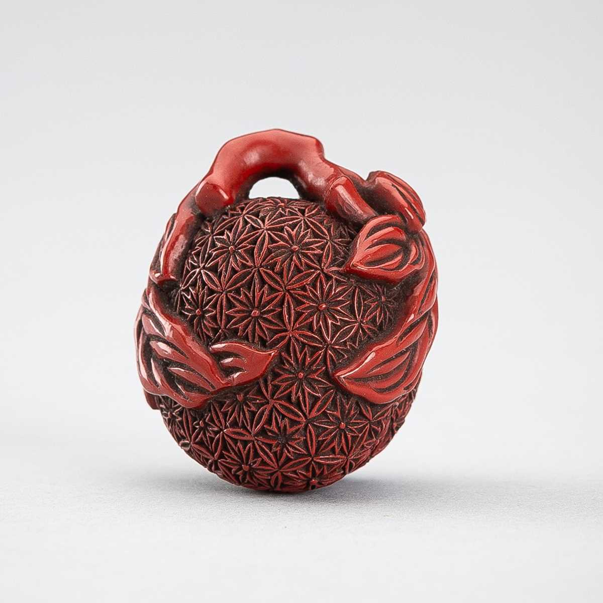 Lot 664 - A FINE TSUISHU (CARVED RED LACQUER) NETSUKE