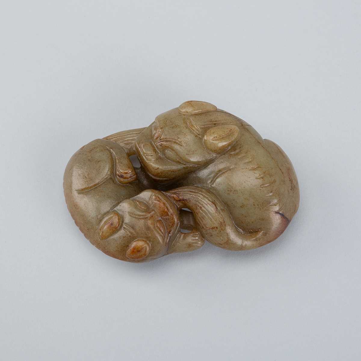 Lot 1751 - A CELADON AND RUSSET JADE ‘QILIN’ PENDANT,