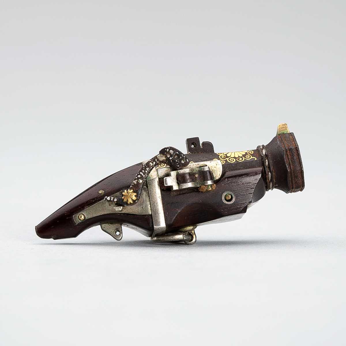 Lot 538 - A WOOD AND IRON NETSUKE OF A MINIATURE