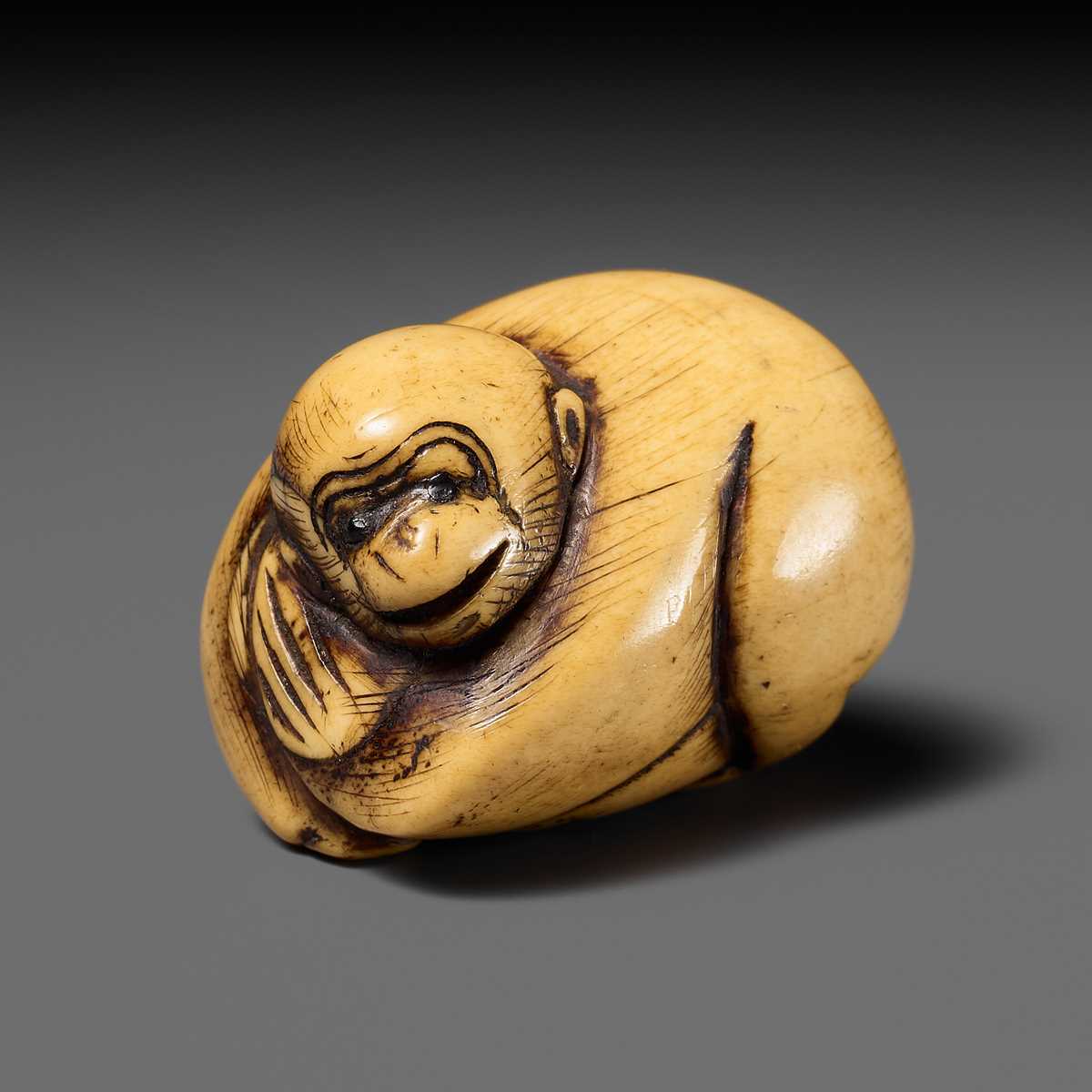 Lot 307 - A FINE ANTLER NETSUKE OF A MONKEY,