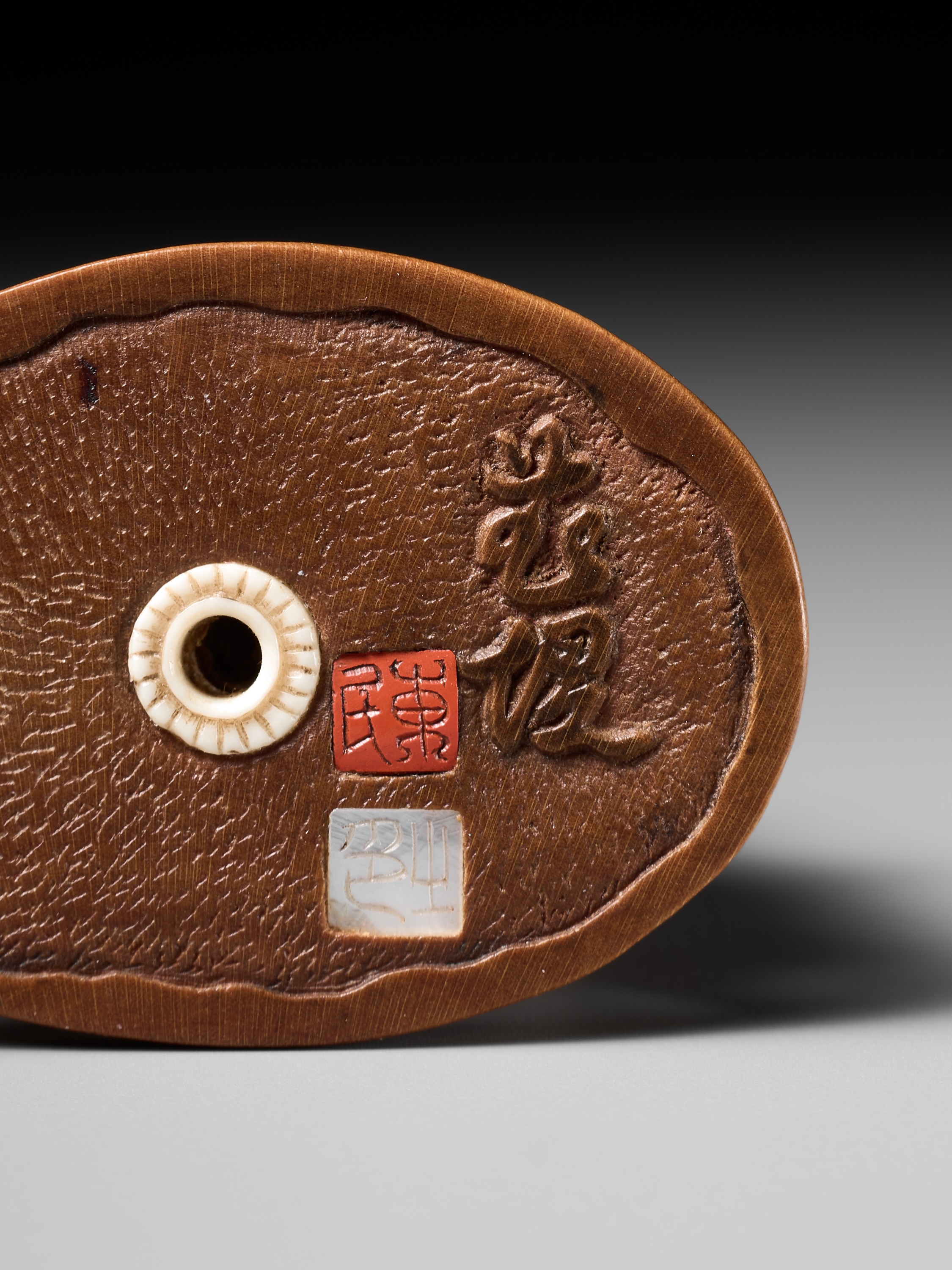 Lot 285 - TOMIN: A WOOD NETSUKE OF SHOKI RIDING A LION