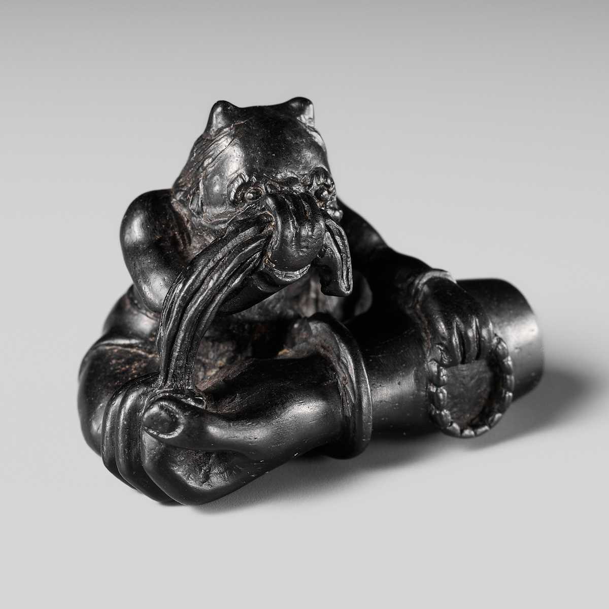 Lot 514 - KOGETSU: A FINE EBONY WOOD NETSUKE OF AN ONI