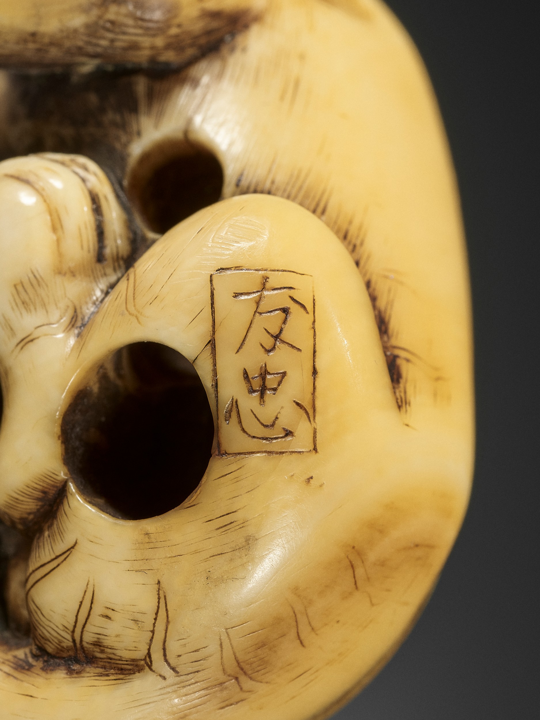 Lot 68 - TOMOTADA: A GOOD IVORY NETSUKE OF A TIGER