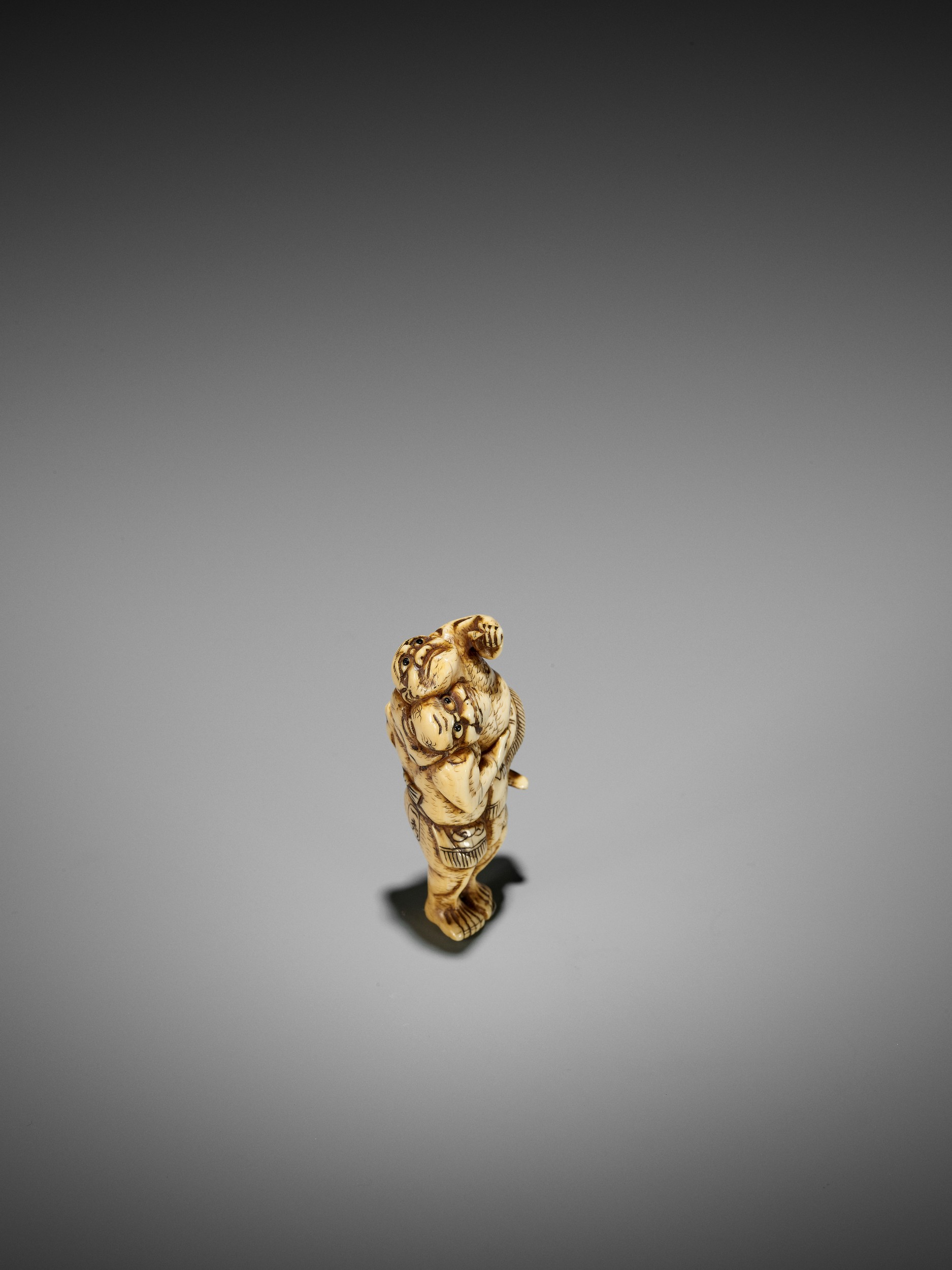 Lot 70 - ISSHU: AN IVORY NETSUKE OF TWO SUMO WRESTLERS