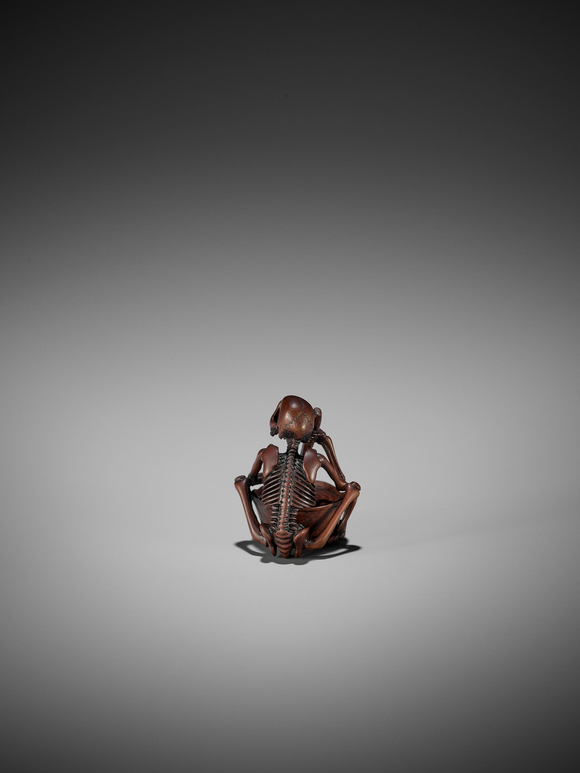 Lot 123 - SHOKO: A FINE WOOD NETSUKE OF A SKELETON
