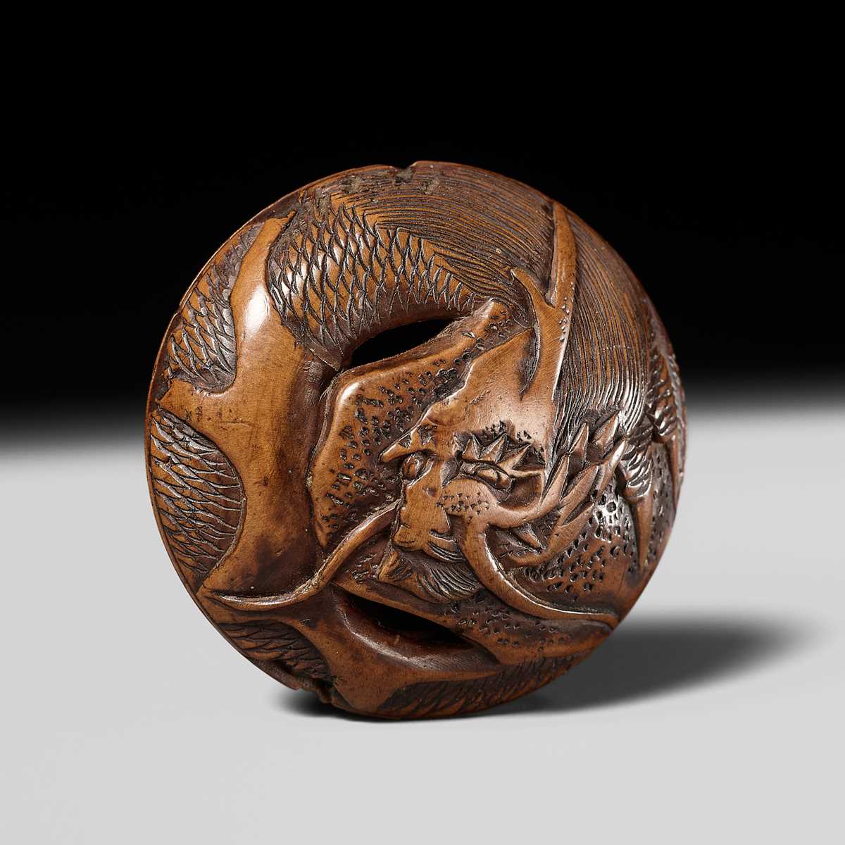 Lot 524 - A WOOD RYUSA MANJU NETSUKE OF A COILED