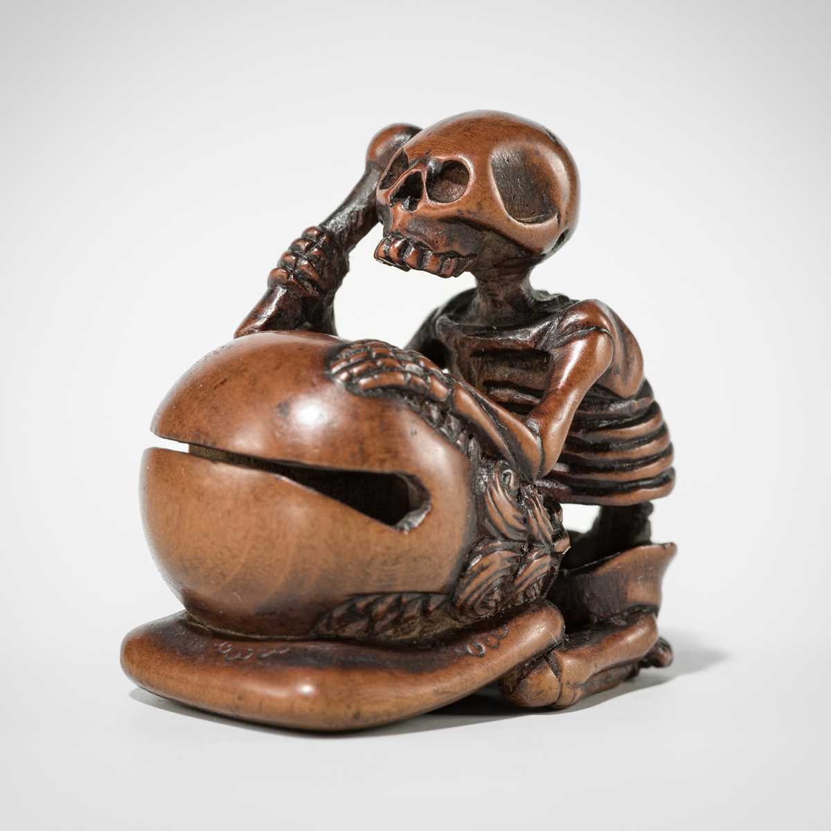 Lot 512 - TOMOMASA: A WOOD NETSUKE OF A SKELETON