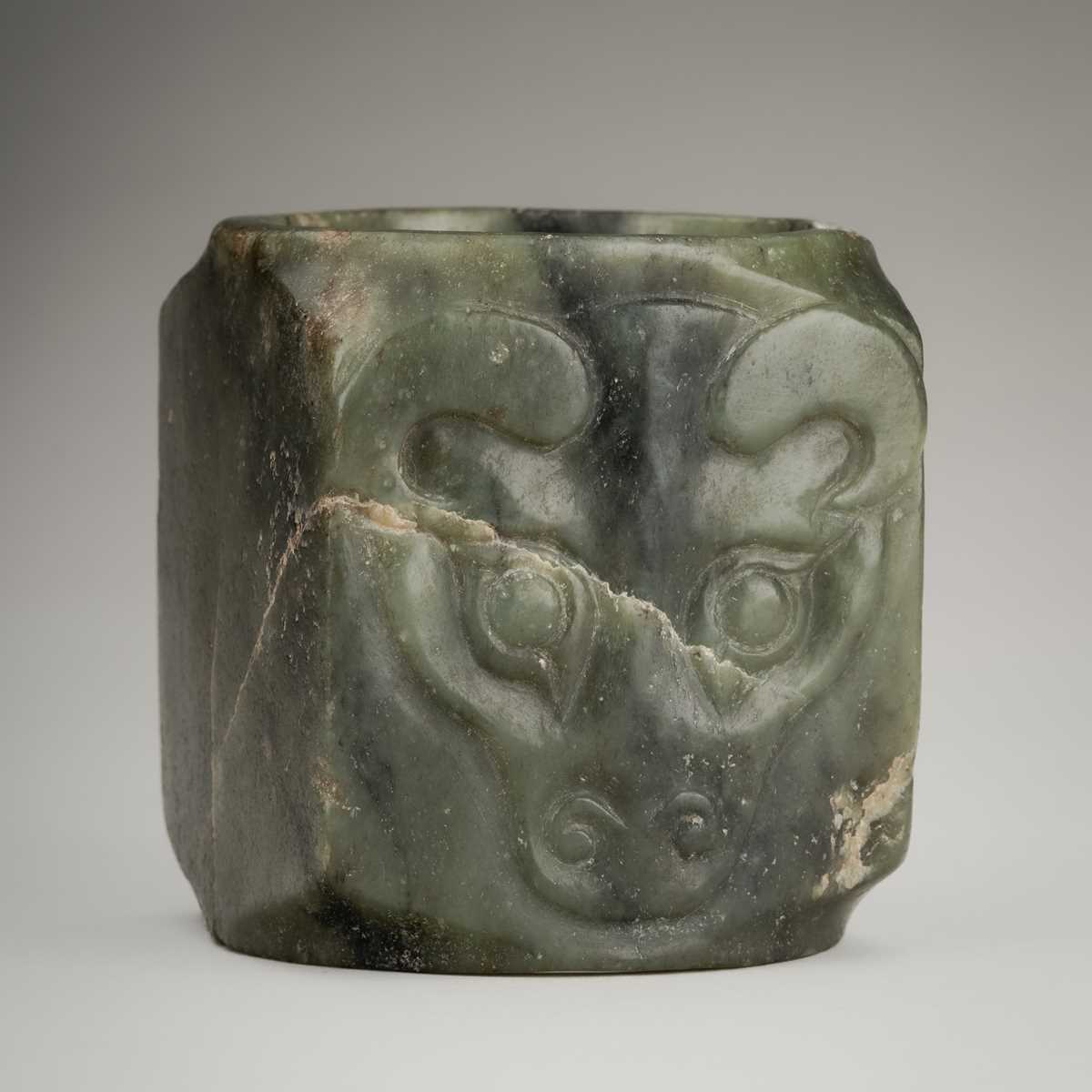Lot 833 - AN ARCHAISTIC JADE CONG WITH BULL CARVINGS,