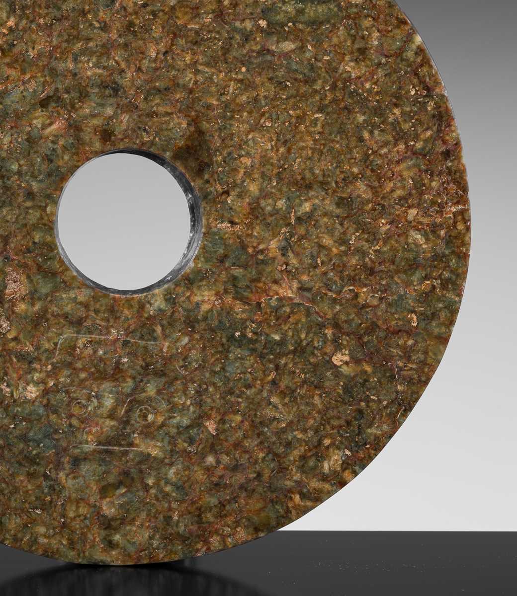 Lot 129 - A JADE 'MASK' BI DISK, NEOLITHIC PERIOD,