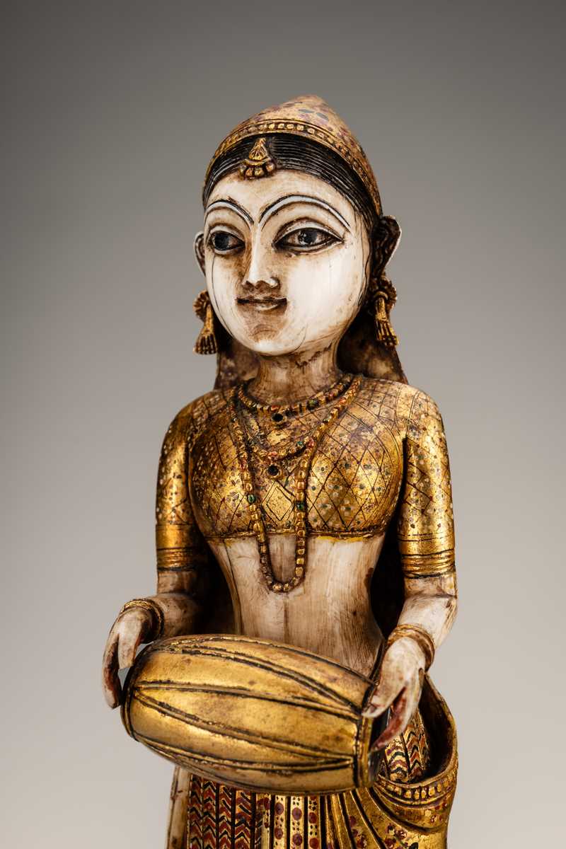 Lot 987 - A POLYCHROME AND GILT IVORY FIGURE OF A