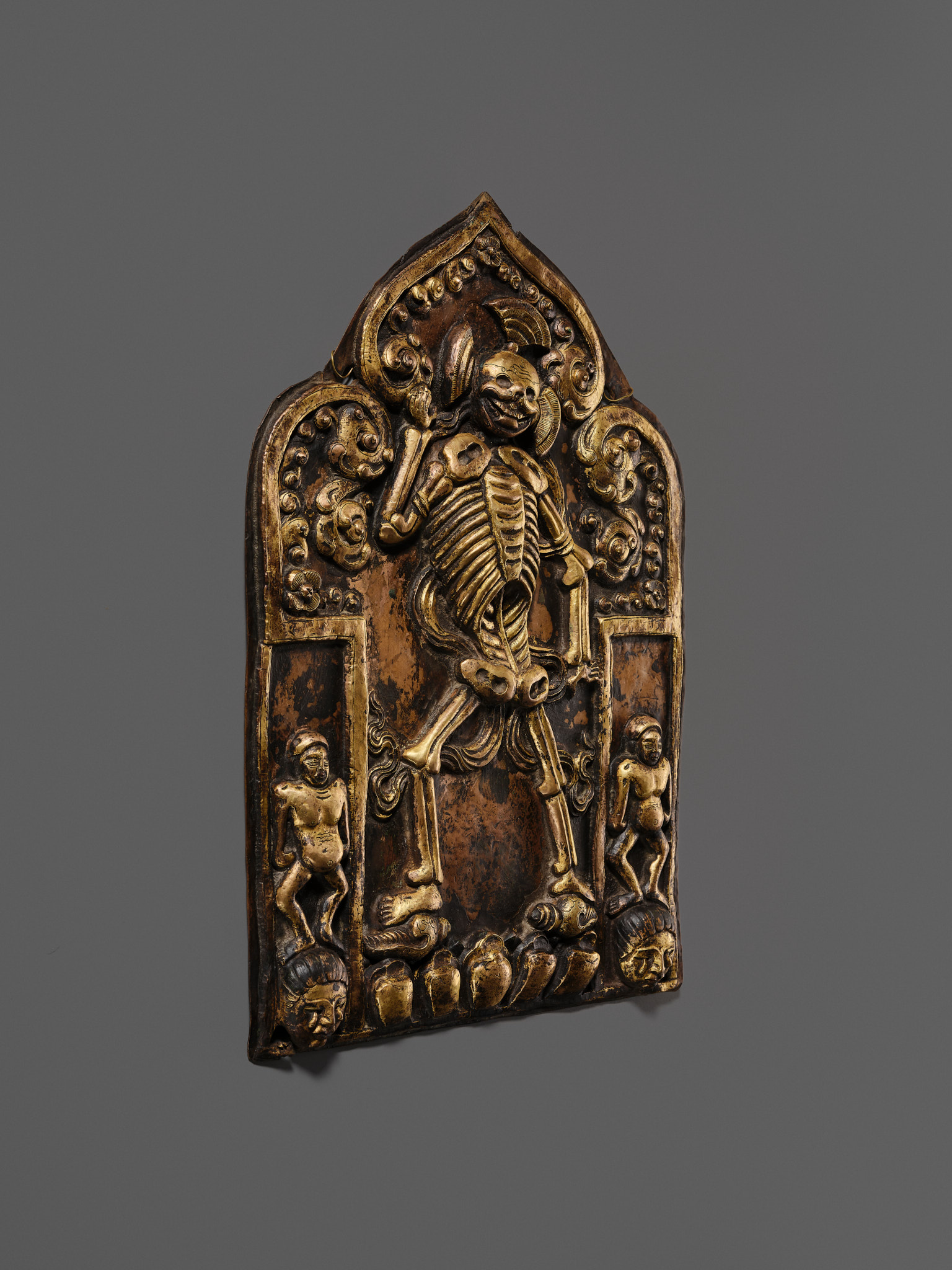 Lot 13 - A GILT COPPER-ALLOY REPOUSSÉ PLAQUE DEPICTING