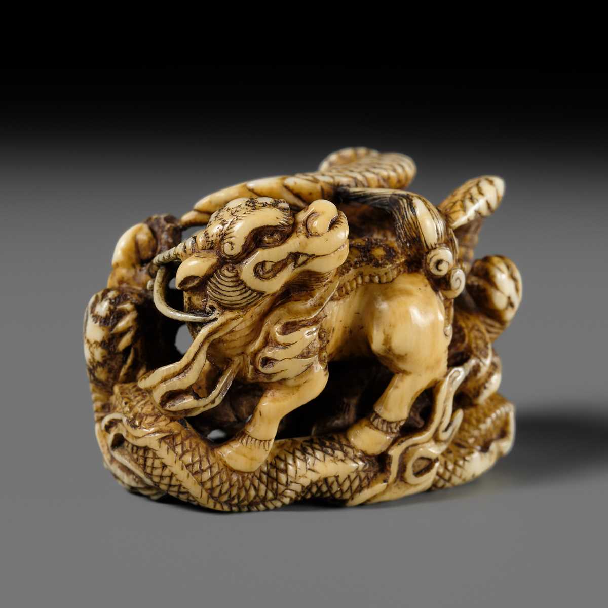 Lot 262 - A RARE IVORY NETSUKE OF THE FOUR HOLY BEASTS