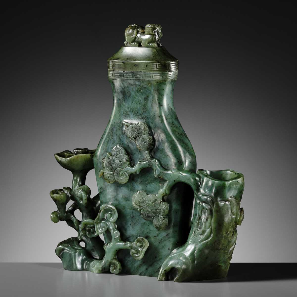 Lot 436 - A SPINACH GREEN JADE ‘PINE, BAT AND LINGZHI’