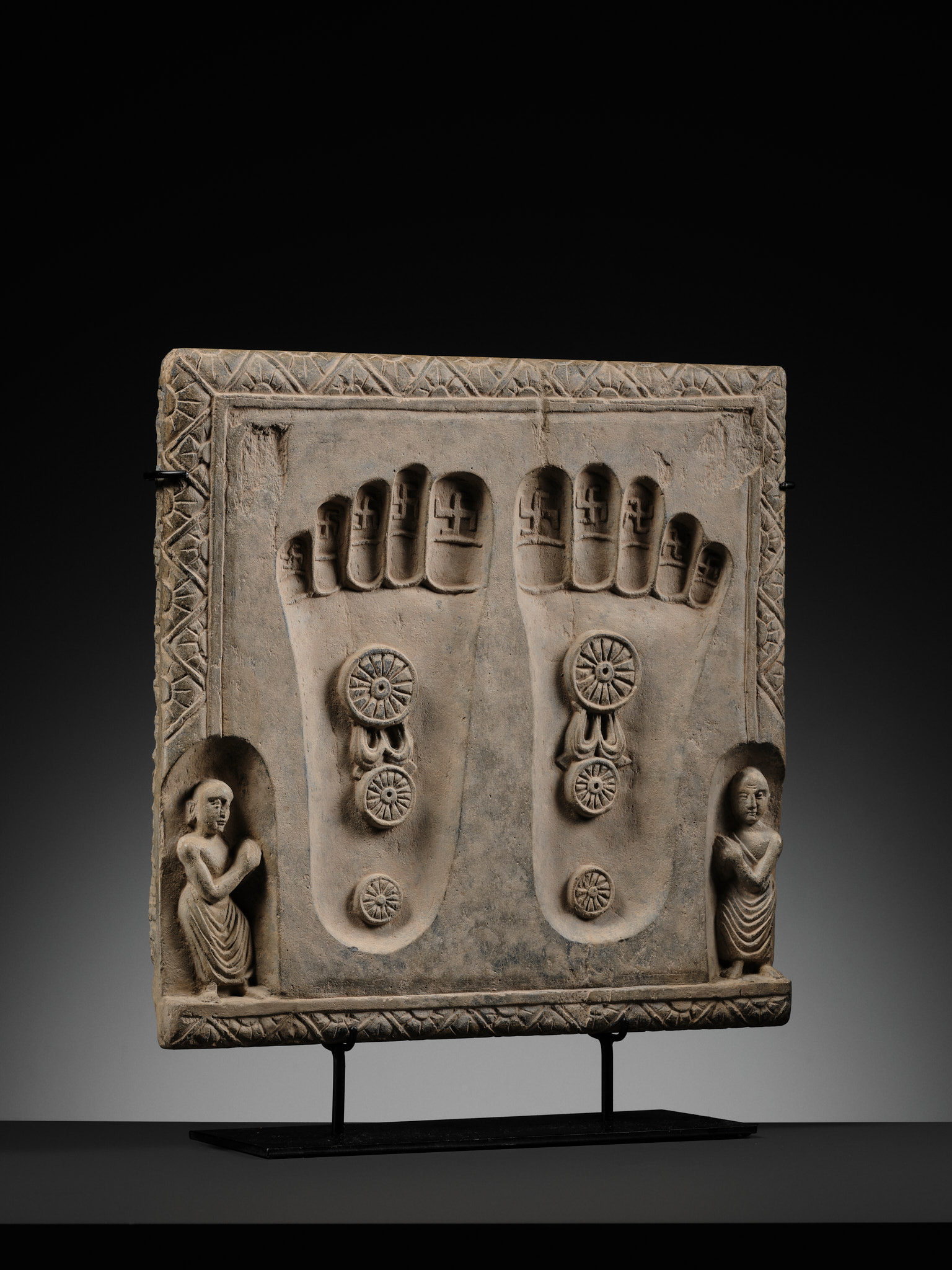 Lot 187 - A SCHIST RELIEF OF THE FOOTPRINTS OF BUDDHA,