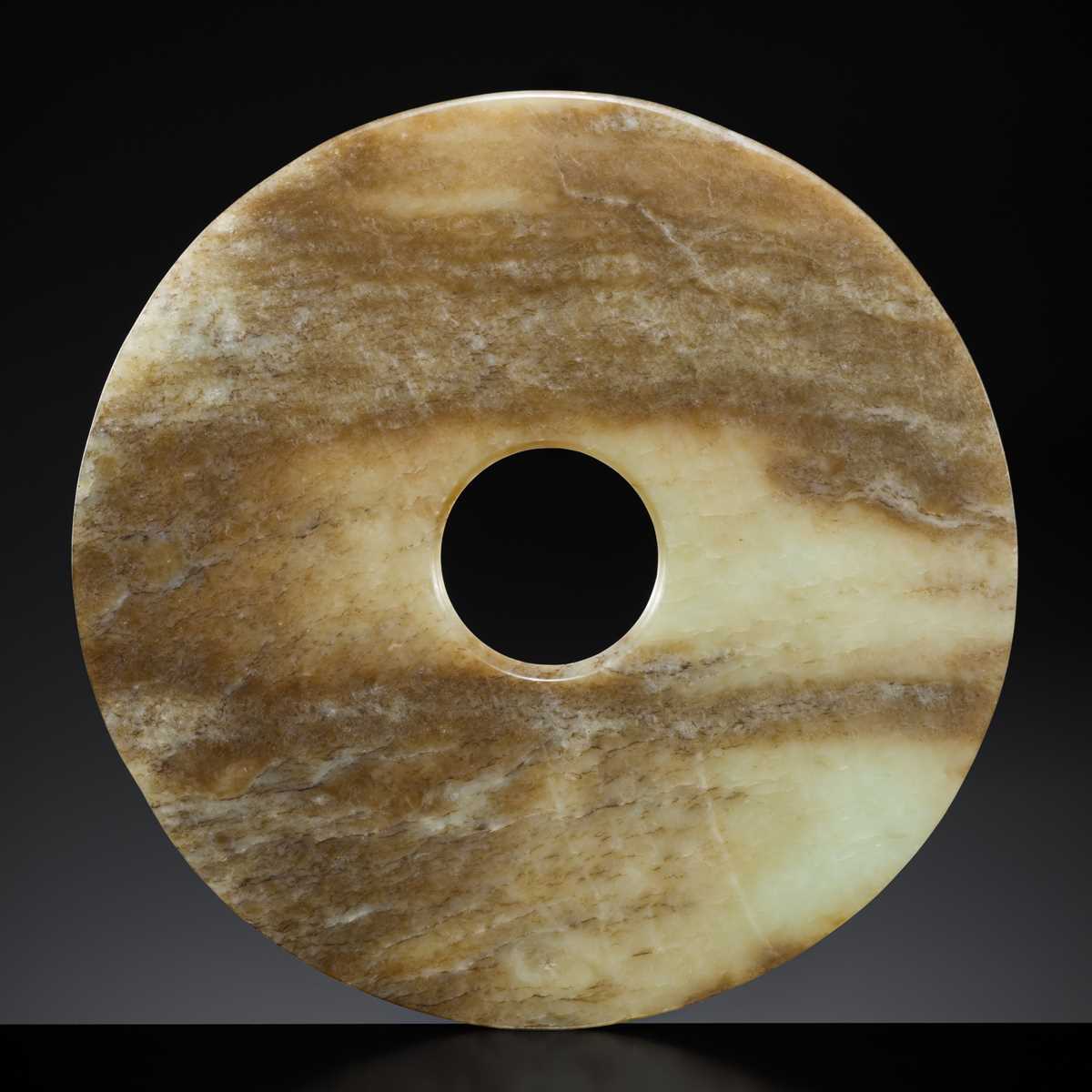 Lot 412 - A CELADON AND BROWN JADE DISC, BI, NEOLITHIC