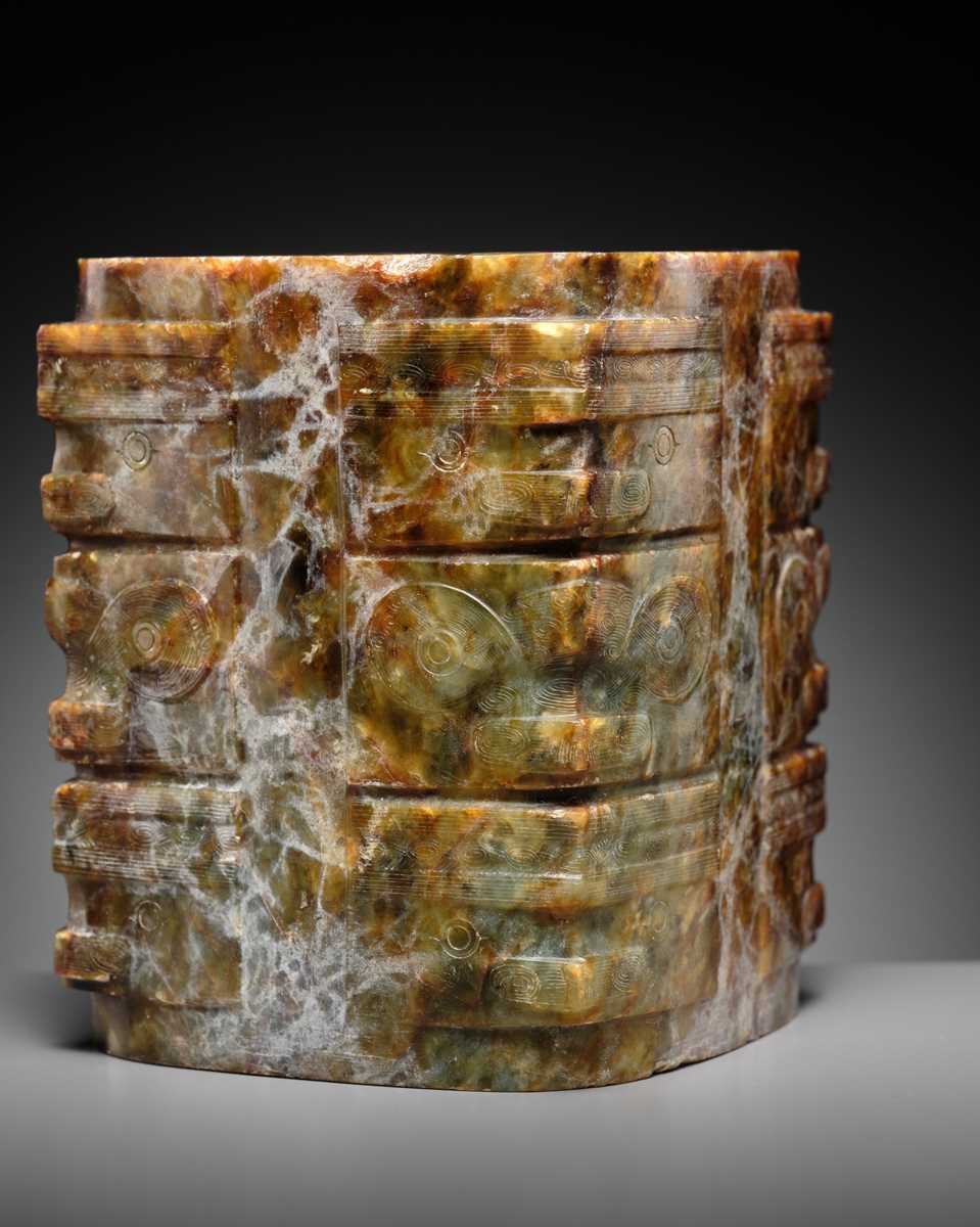 Lot 411 - A NEOLITHIC MOTTLED BROWN JADE CONG,