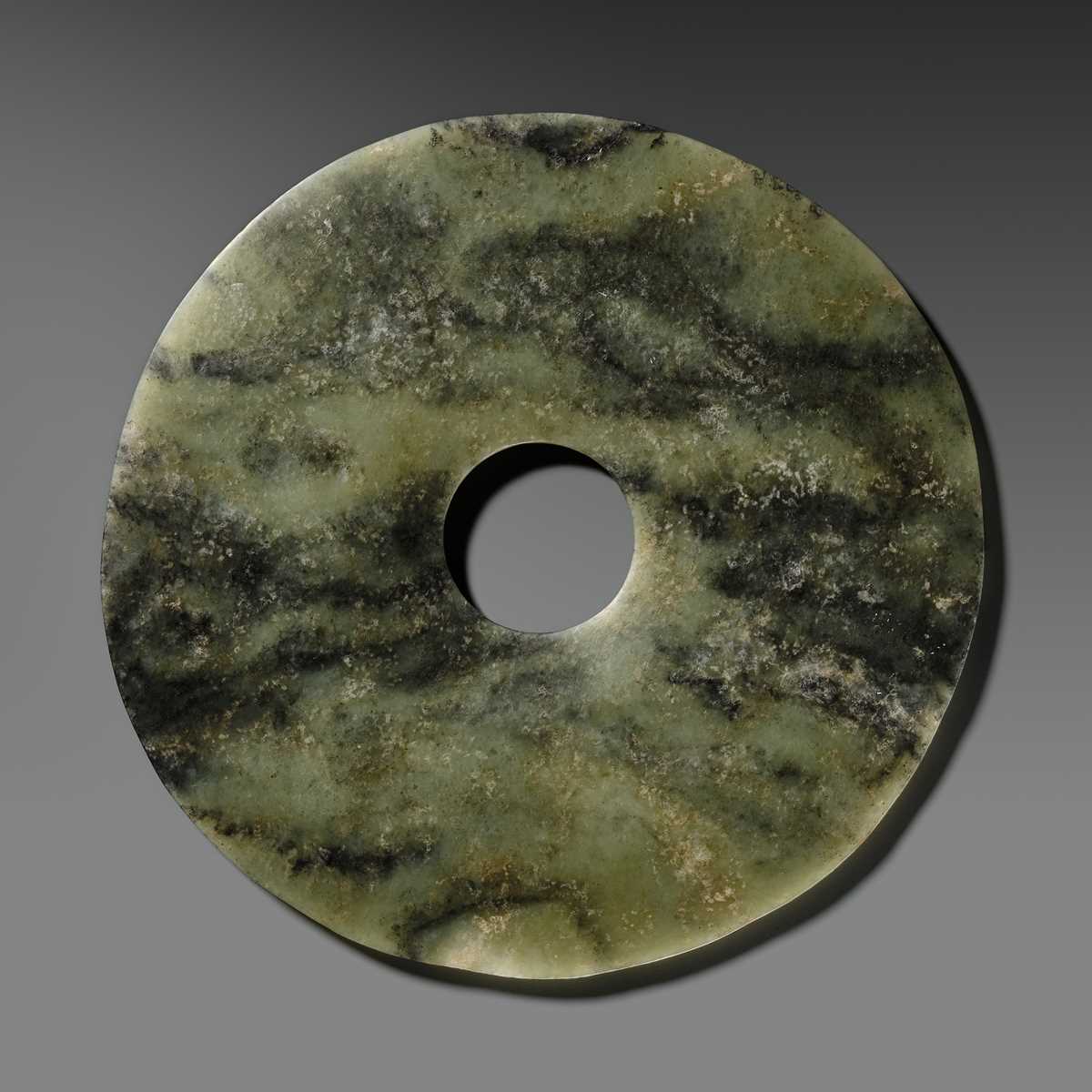 Lot 146 - A LARGE MOTTLED GREEN JADE DISK, BI,